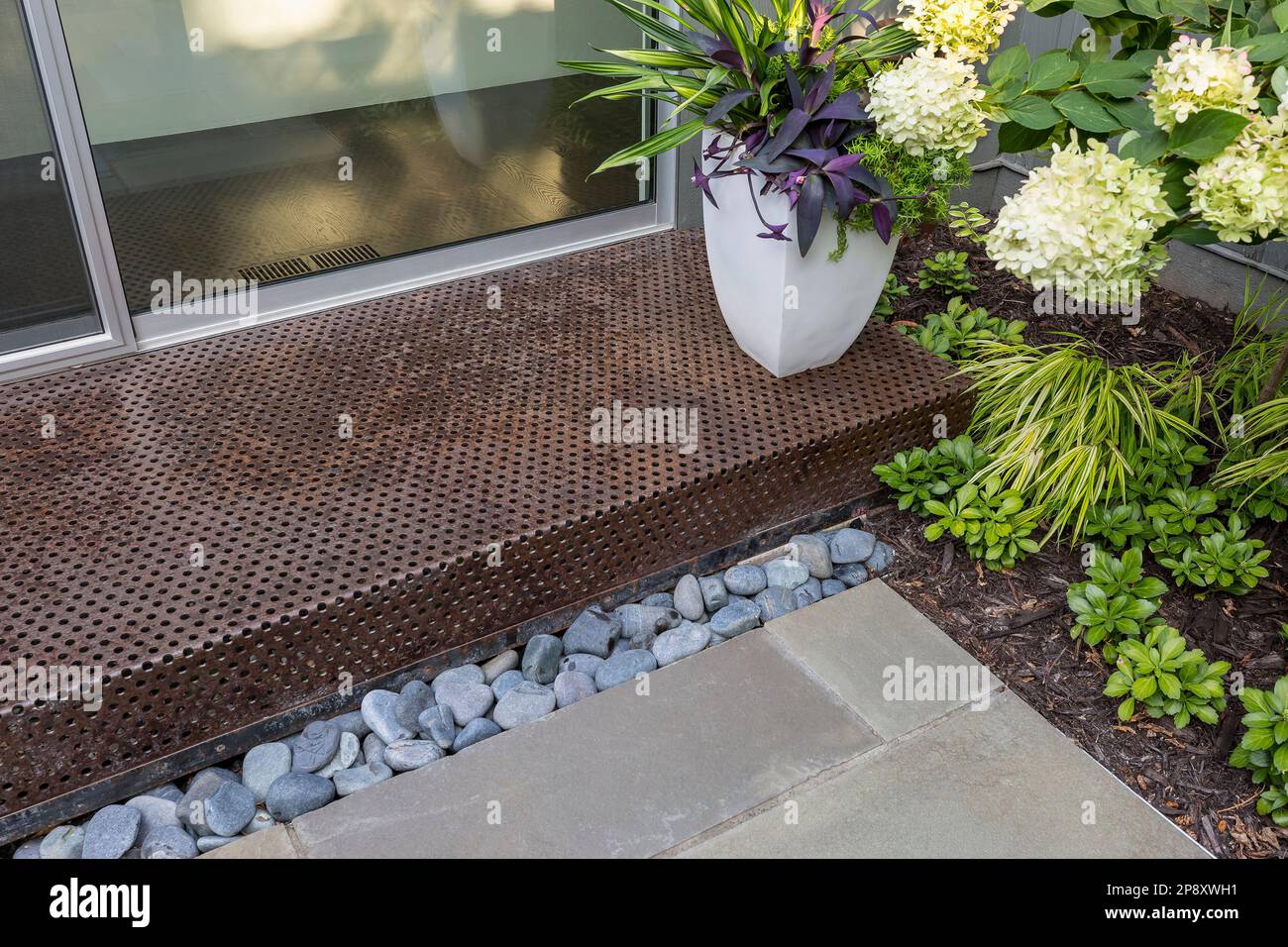 Smooth river rocks between step and patio for drainage hi-res stock ...