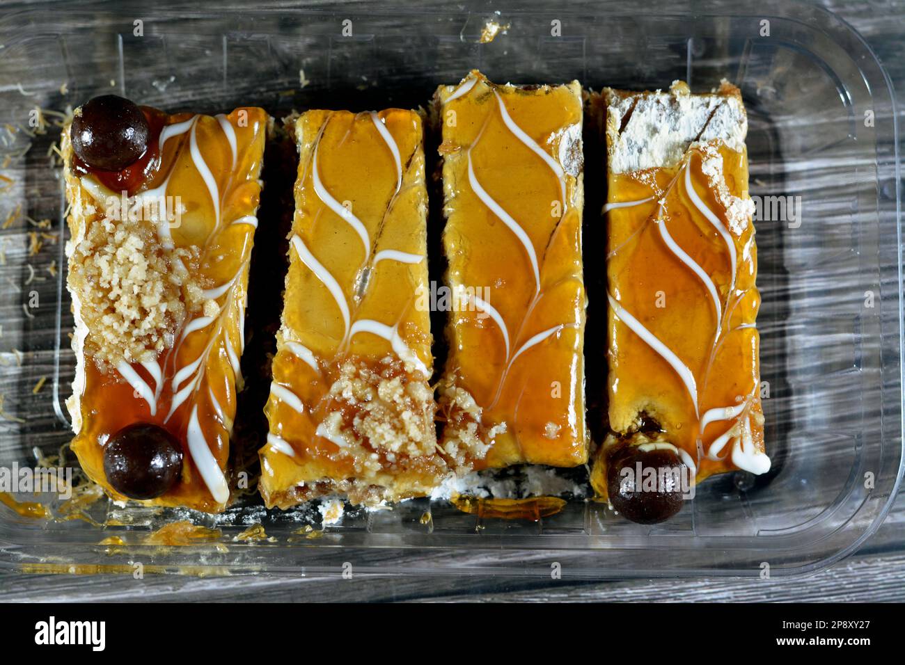 Egyptian dessert made of layers of basbousa semolina cake, kunafa ...