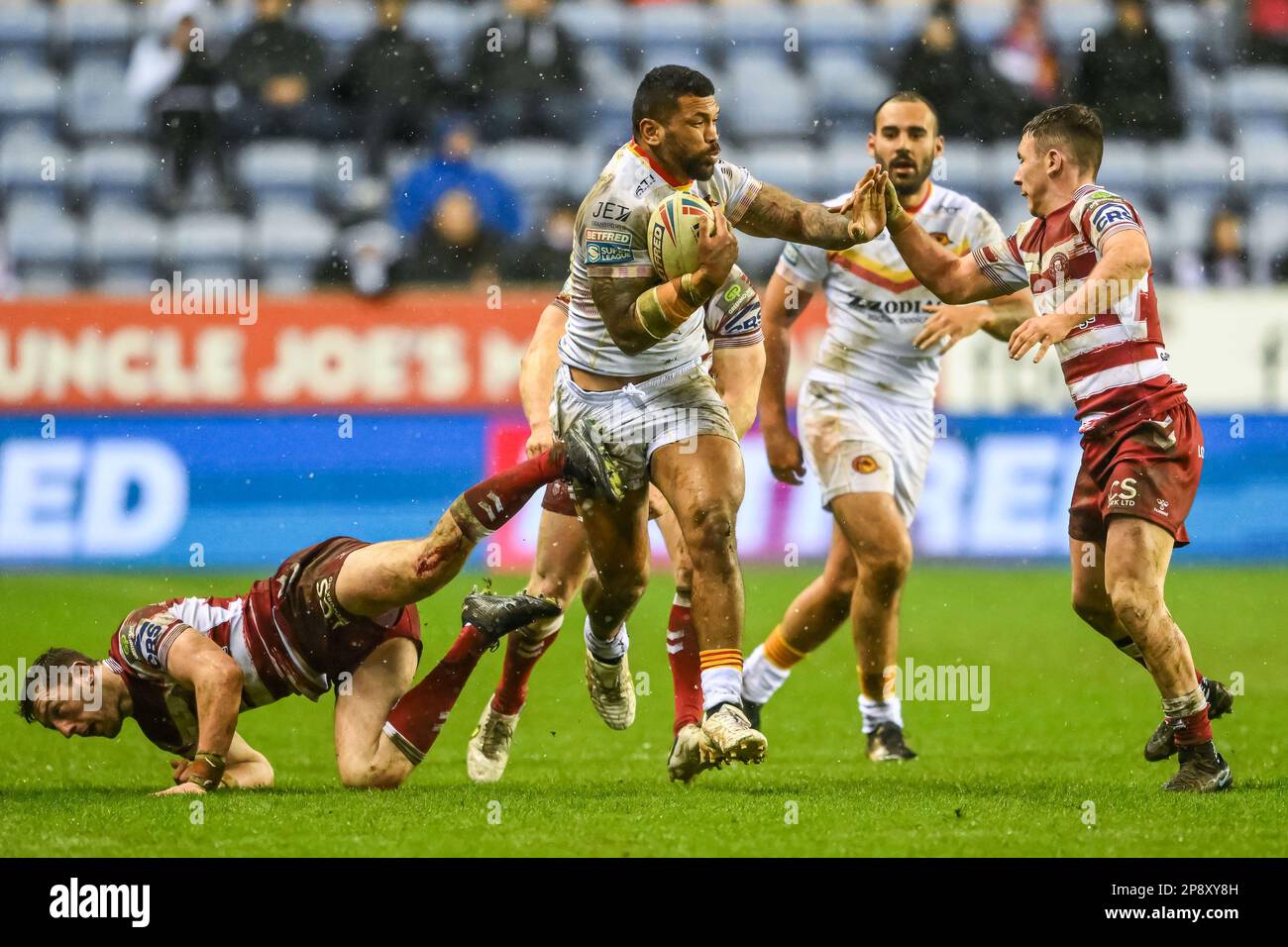 Manu Ma’u #26 of Catalans Dragons breaks the tackle of Jake Wardle #4 ...