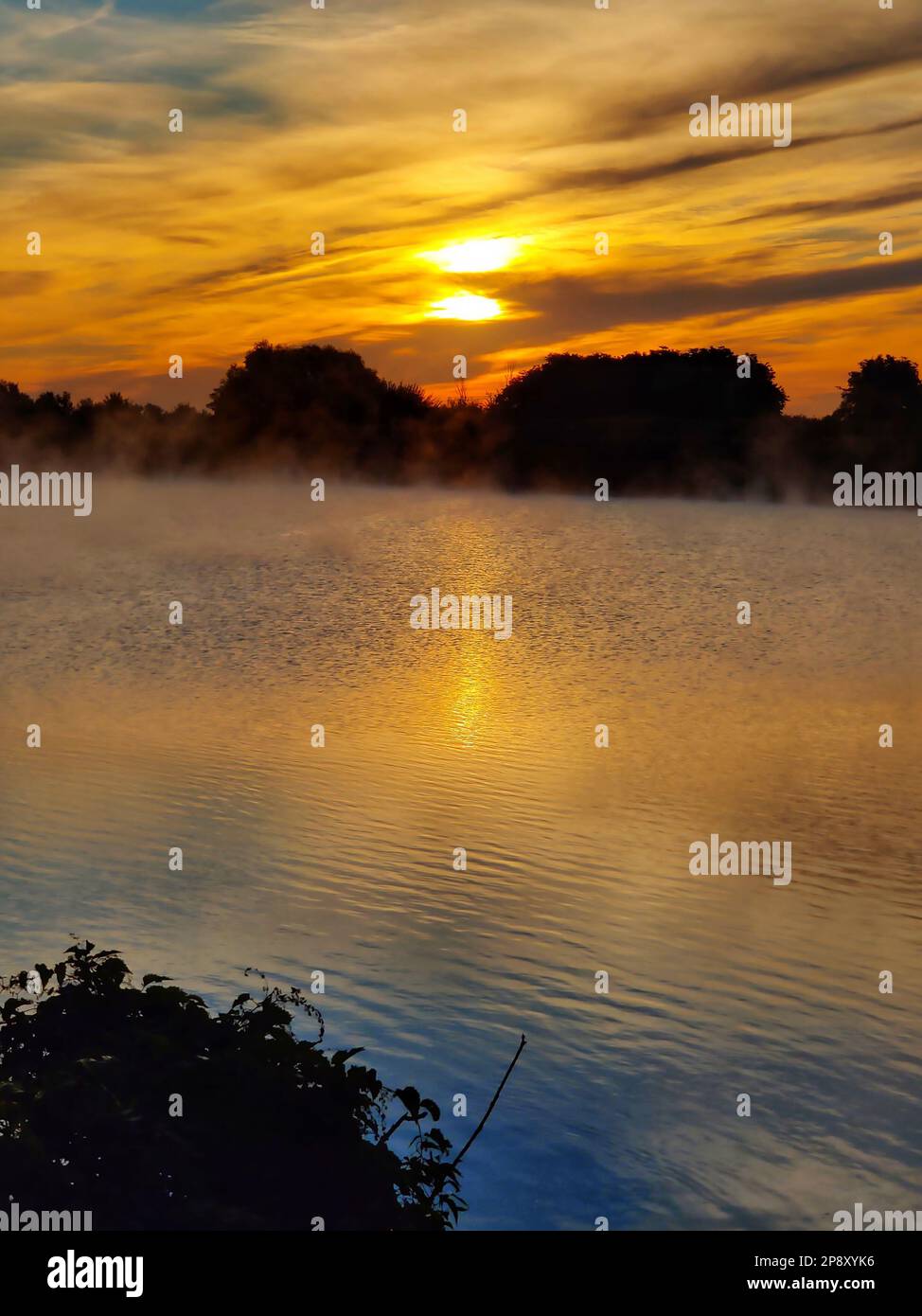 The sun rises over the lake. fog over water, landscape Stock Photo - Alamy