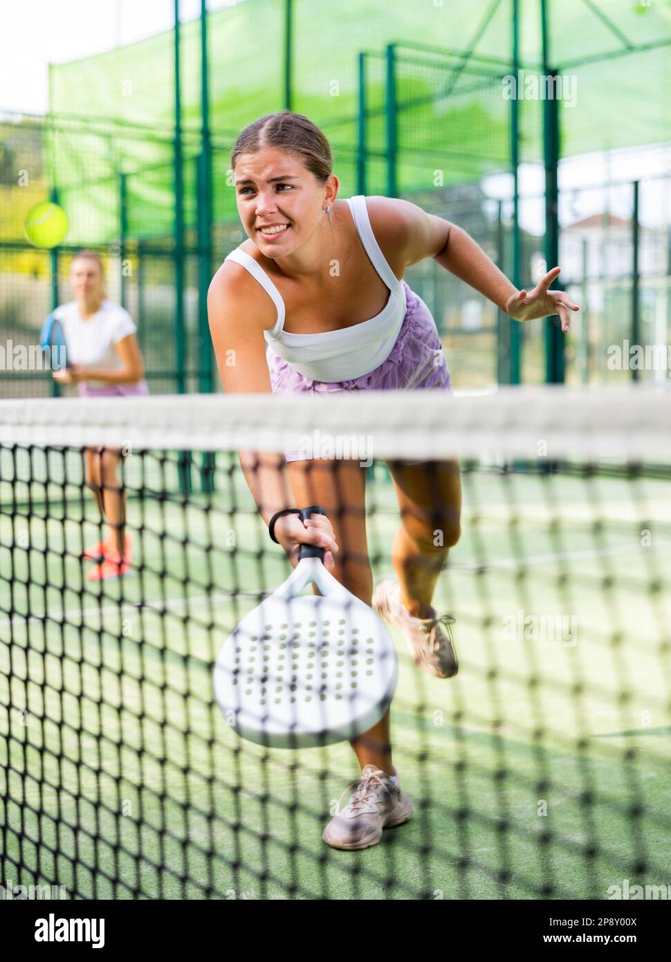 Young woman padel tennis player trains on the outdoor court Stock Photo ...