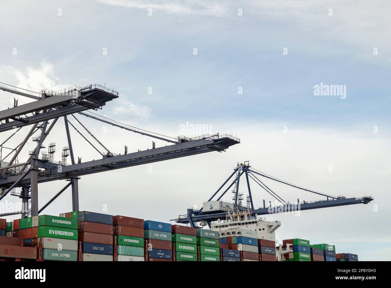 Cargo container ship at dock with shipping containers on deck loading ...