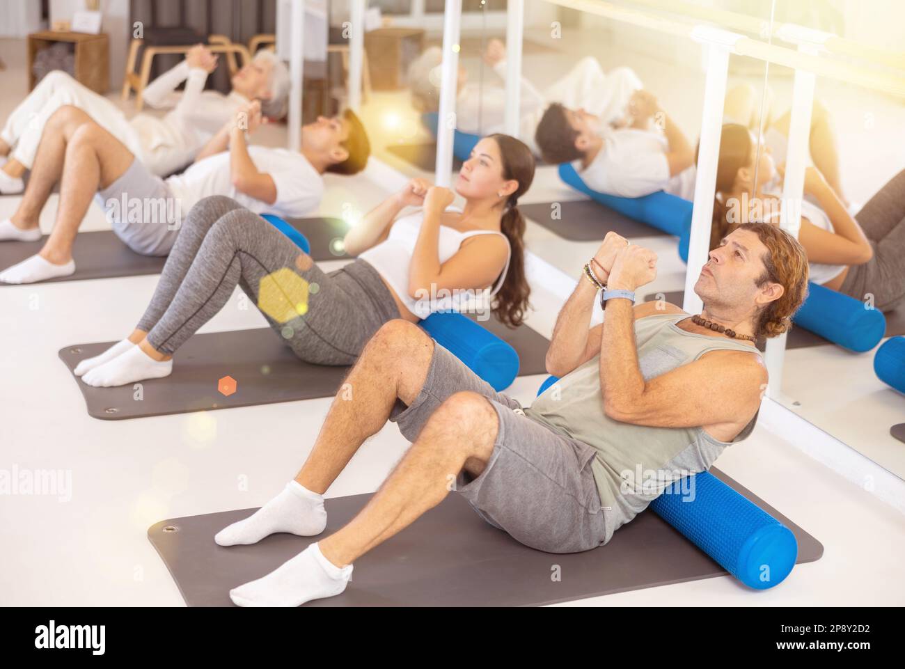 Group of people doing hip bridge exercise in gym Stock Photo - Alamy