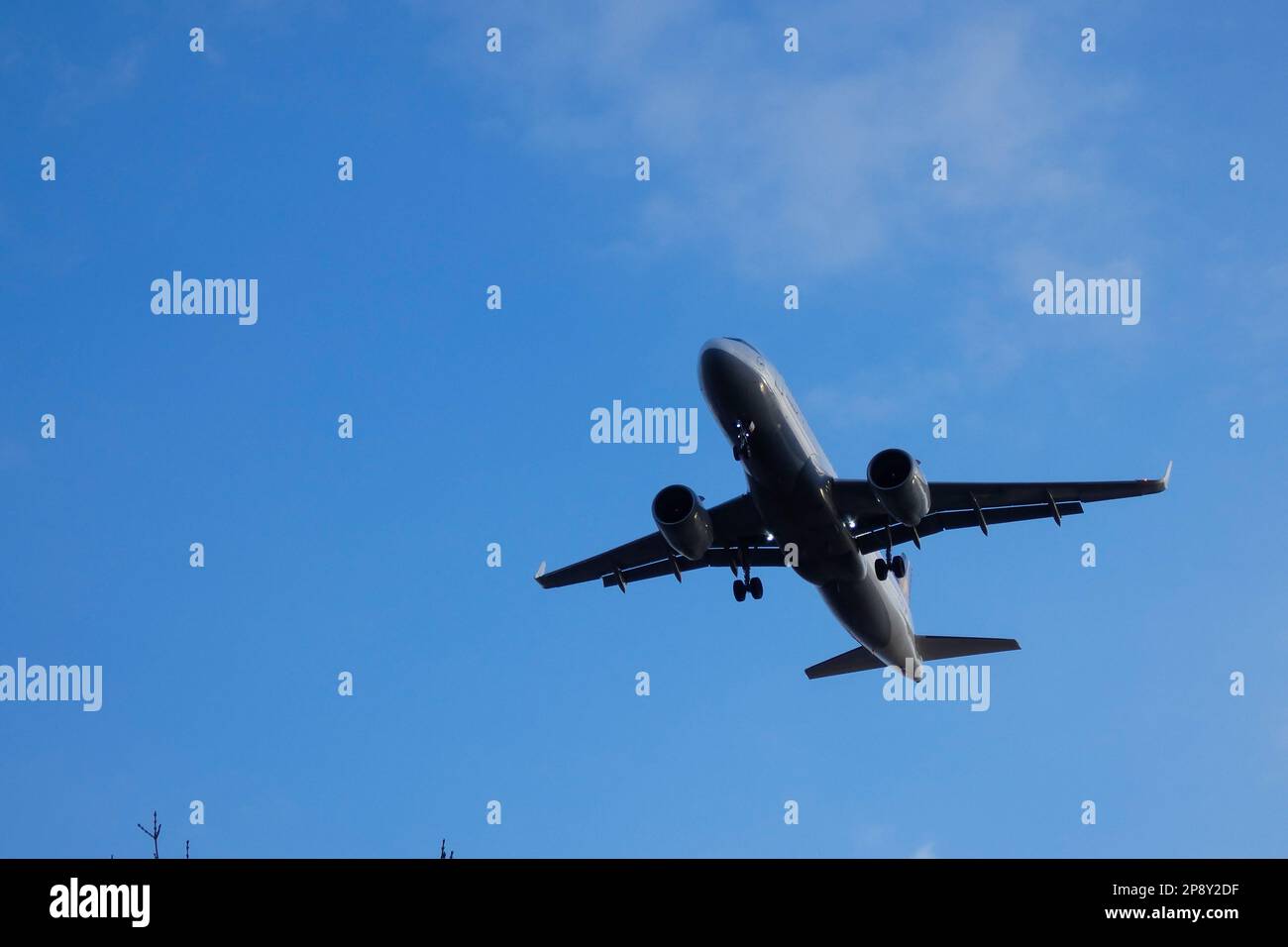 Commercial aircraft overflying the sky and arriving at airport Stock ...