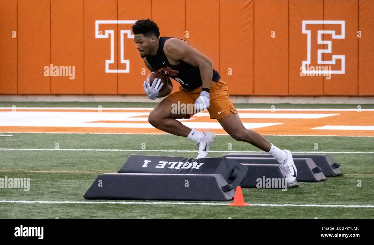 Texas running back Roschon Johnson stumbles over a pad as he works out ...