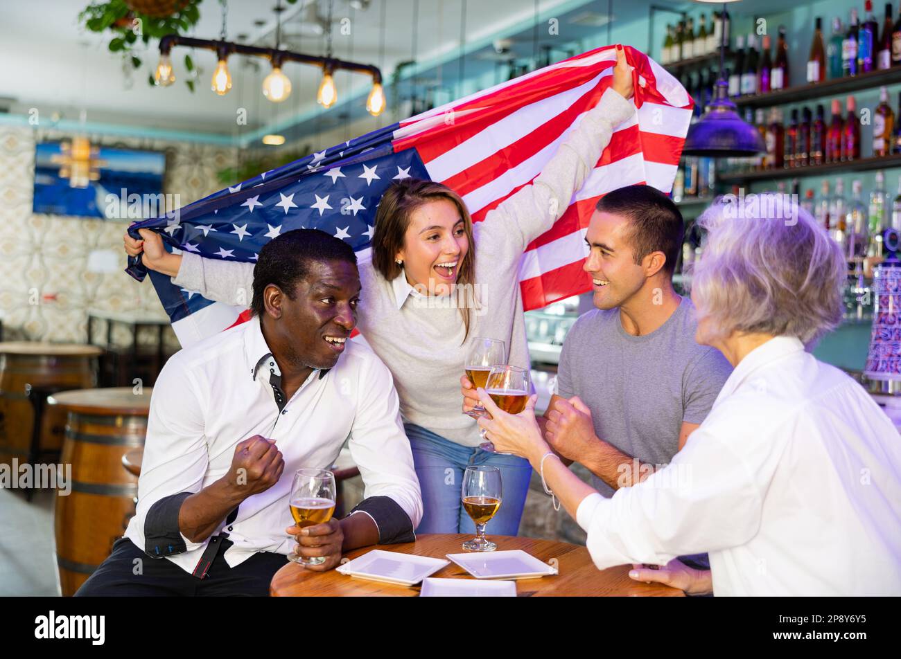 Cheerful american multiracial male and female celebrating spots team ...