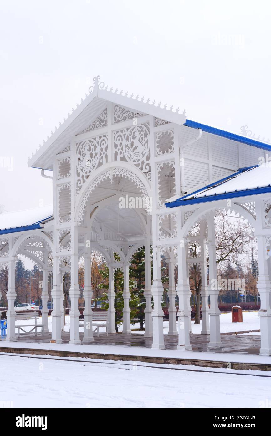 White and blue nostalgic train station under snow in winter. Railtracks ...