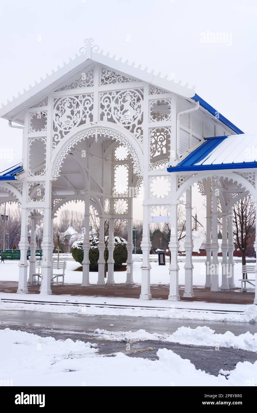 White and blue nostalgic train station under snow in winter. Railtracks ...