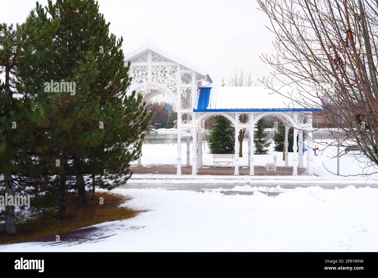 White and blue nostalgic train station under snow in winter. Railtracks ...