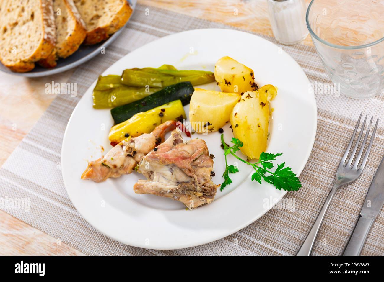 Roasted rabbit served with vegetable garnish Stock Photo - Alamy