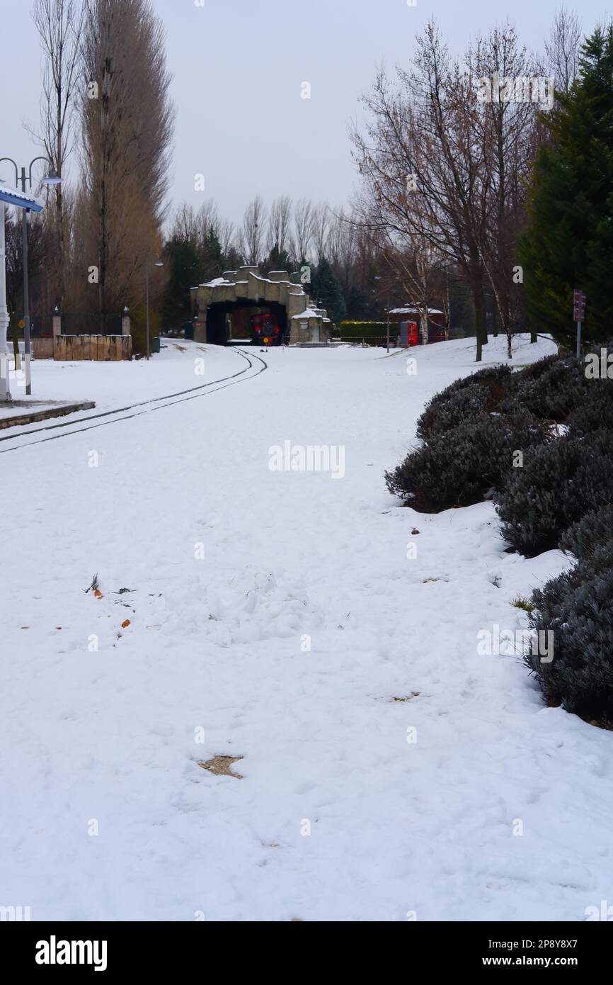 White and blue nostalgic train station under snow in winter. Railtracks ...