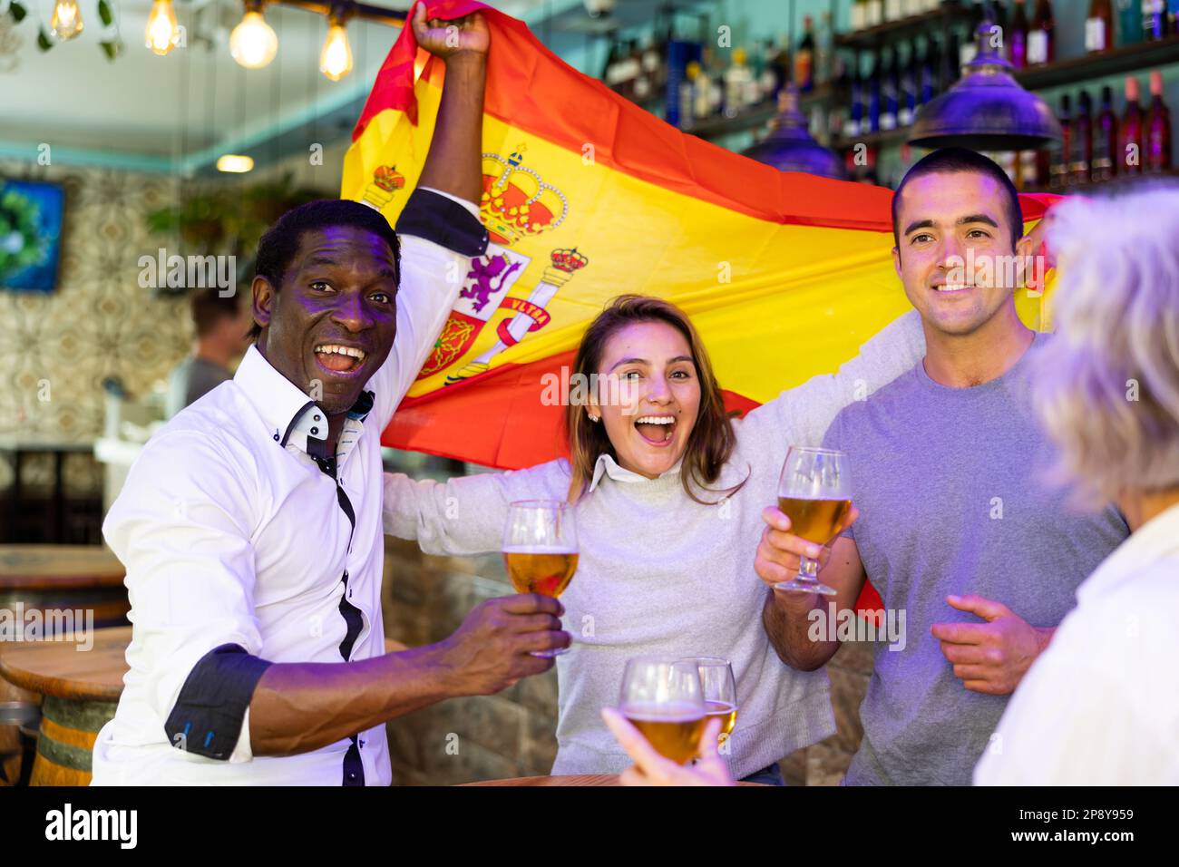 Happy fans celebrating the victory of Spanish team in bar Stock Photo ...