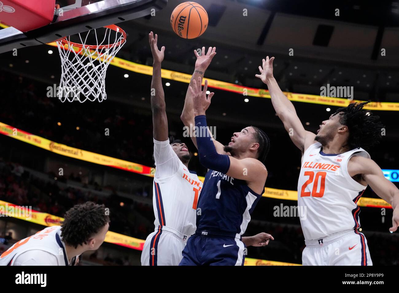 Penn State's Seth Lundy drives to the basket between Illinois's Sencire ...