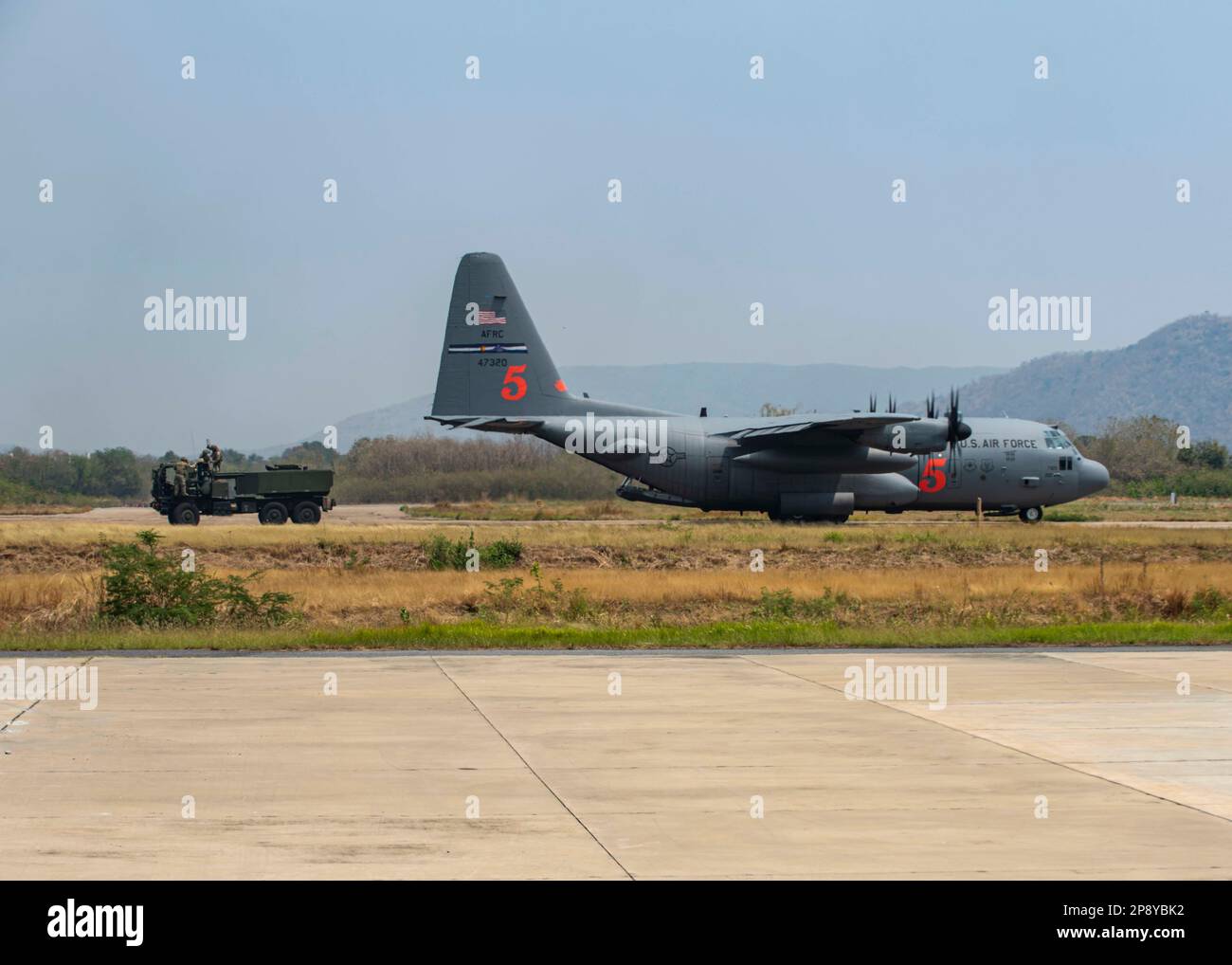 A 302nd Airlift Wing C-130H Hercules delivers a missile pod for a U.S ...