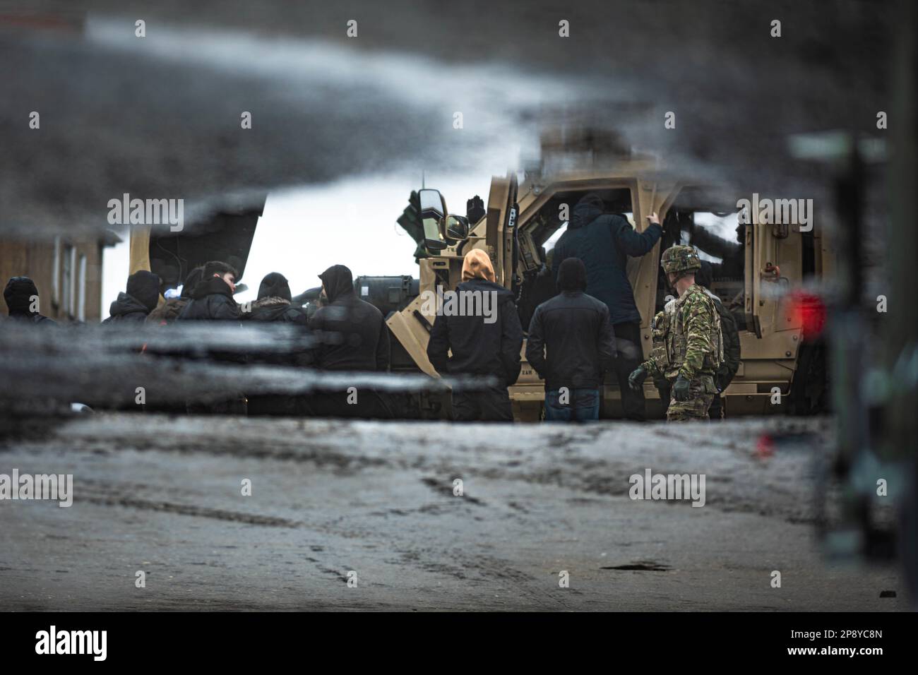 Polish students explore a U.S. Army mine-resistant, ambush-protected all-terrain vehicle while ...