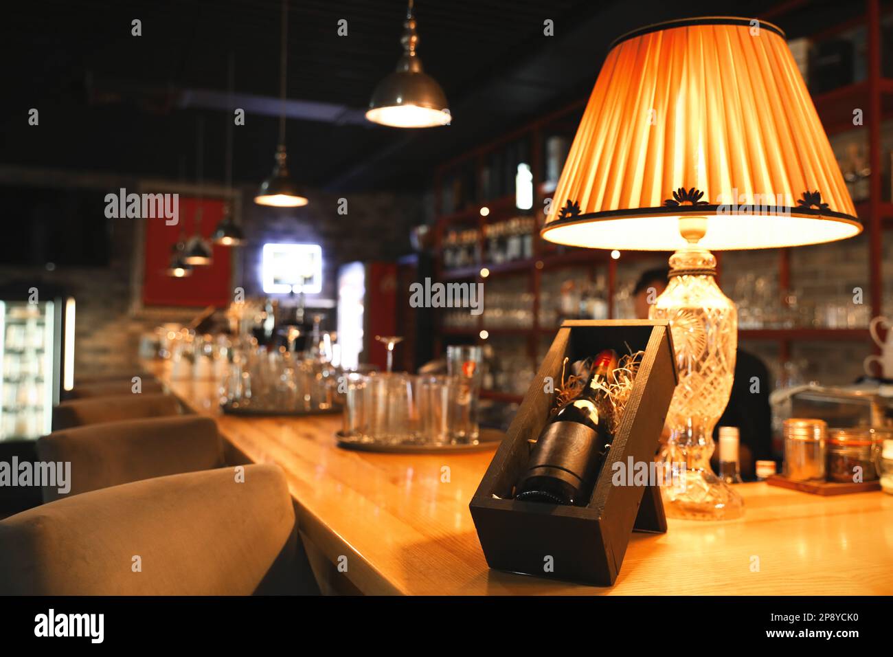 Wooden box with bottle of wine on counter in bar, space for text Stock ...