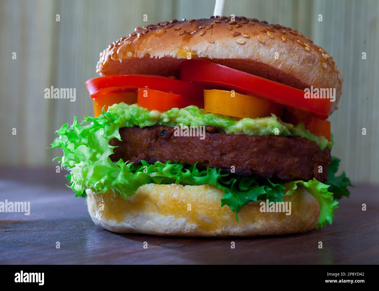 Vegetarian hamburger with soybean patty, tomato, cucumber and lettuce ...