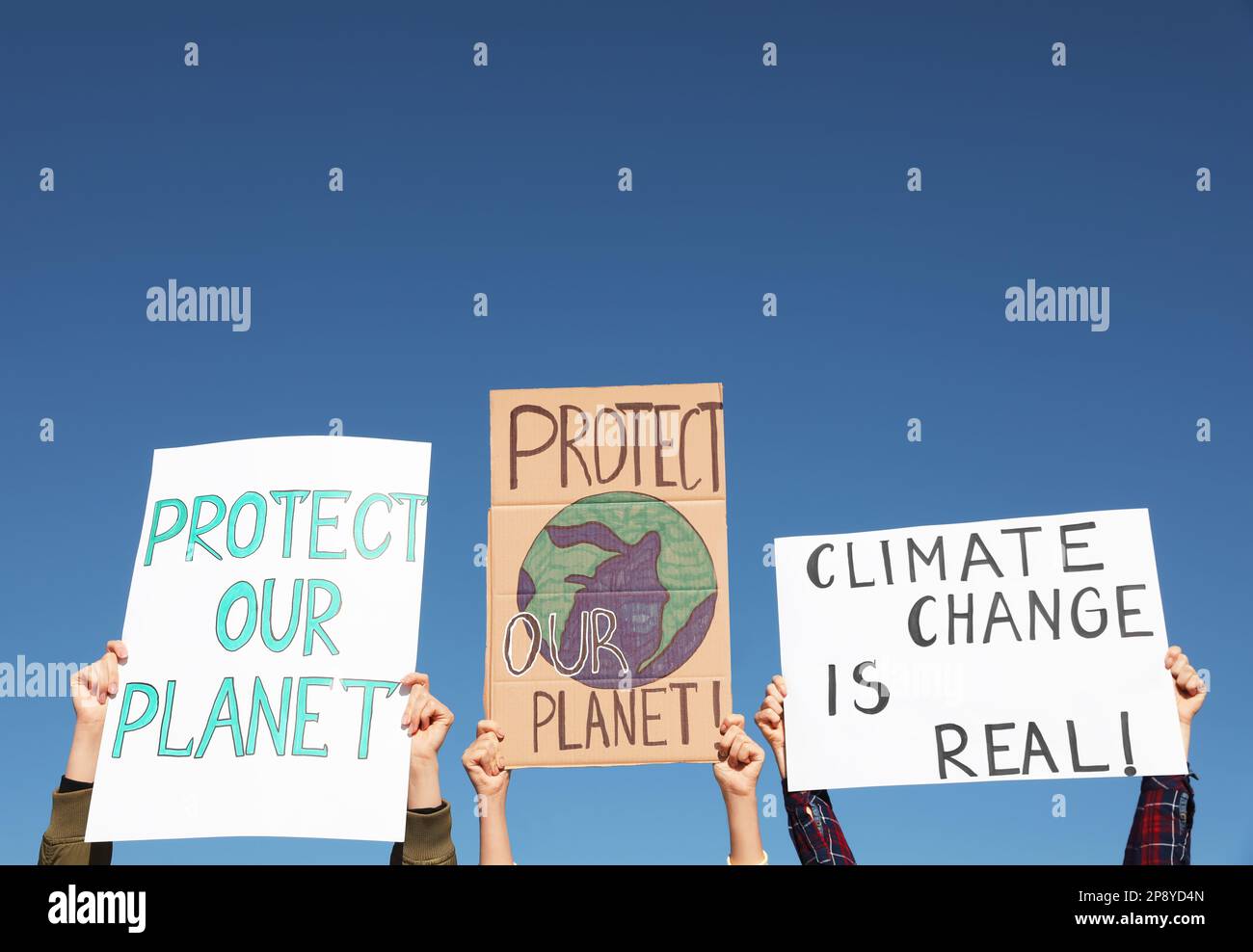 Group of people with posters protesting against climate change outdoors ...
