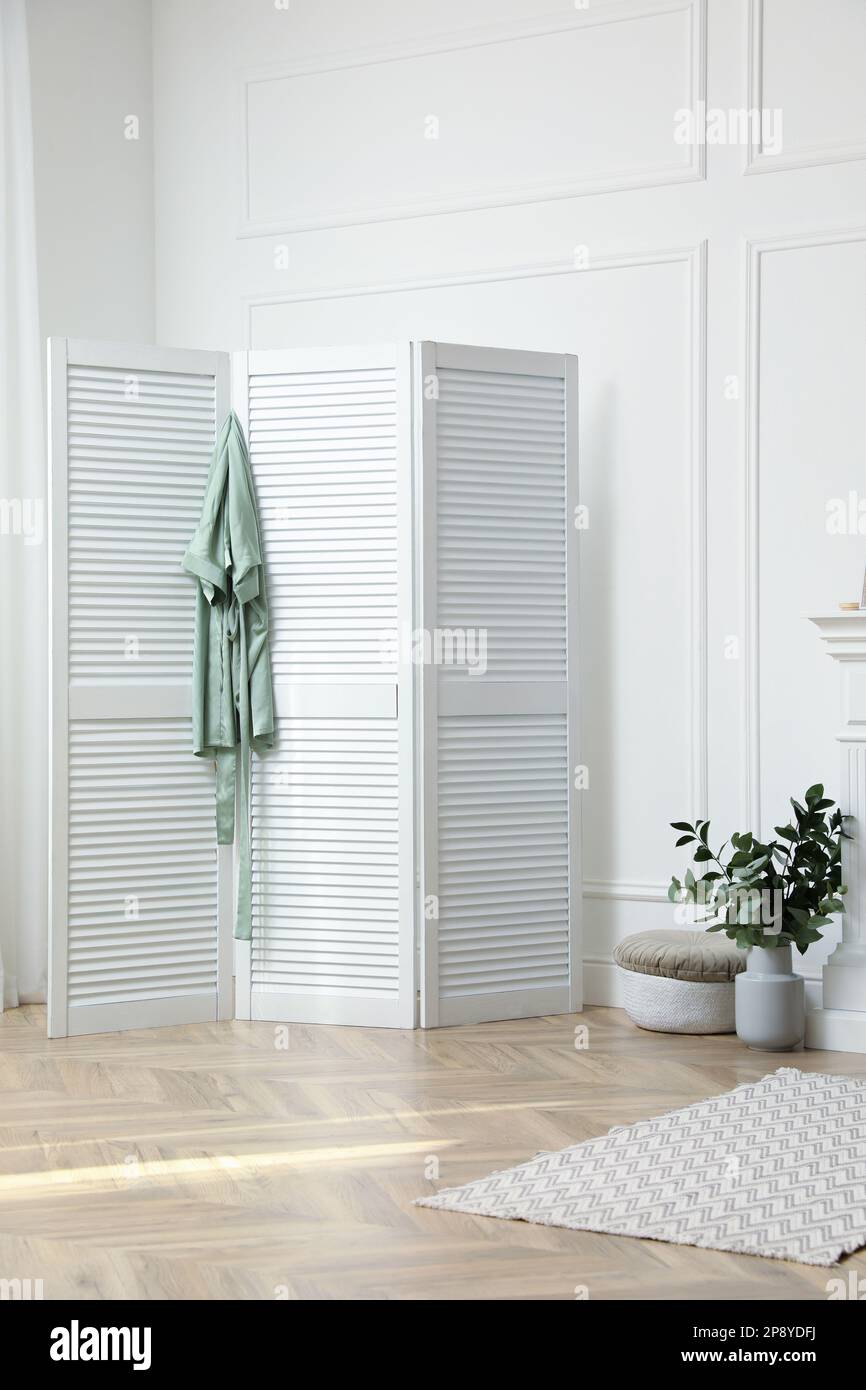 Stylish room with folding screen and floral decor. Interior design ...