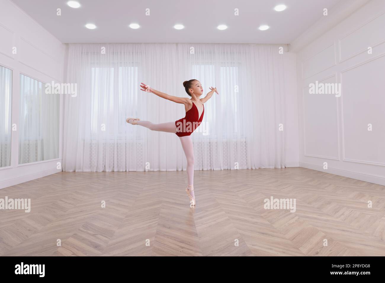 Little ballerina practicing dance moves in studio Stock Photo - Alamy