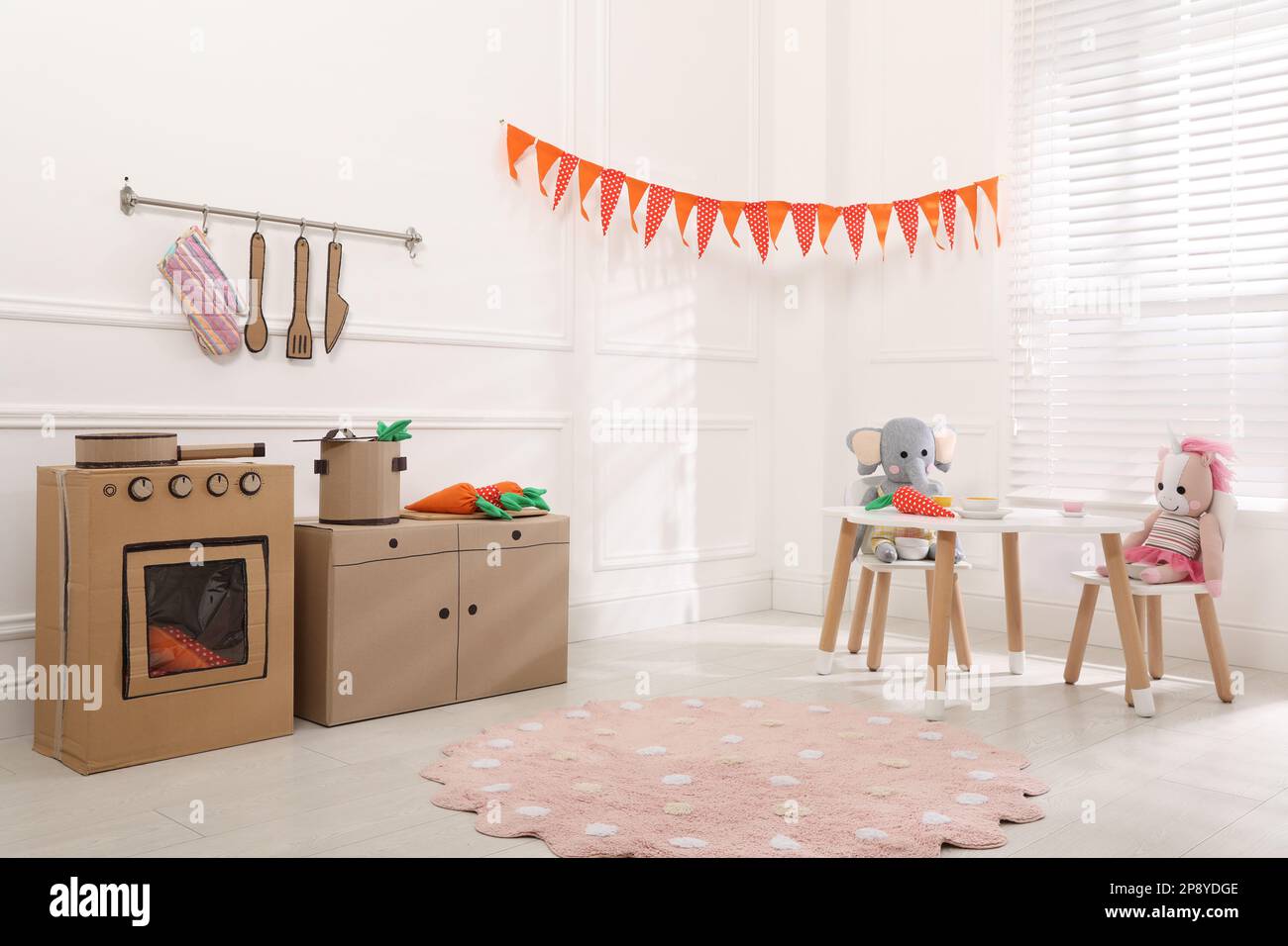 Toy cardboard kitchen with stove and utensils at home Stock Photo - Alamy