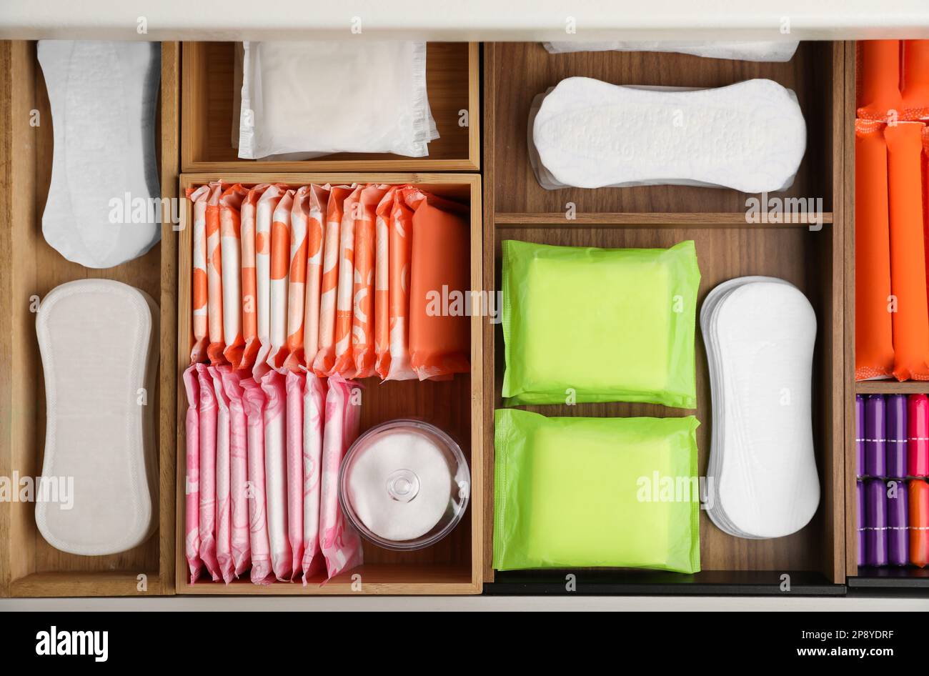 Storage of different feminine hygiene products in wooden drawer, top ...