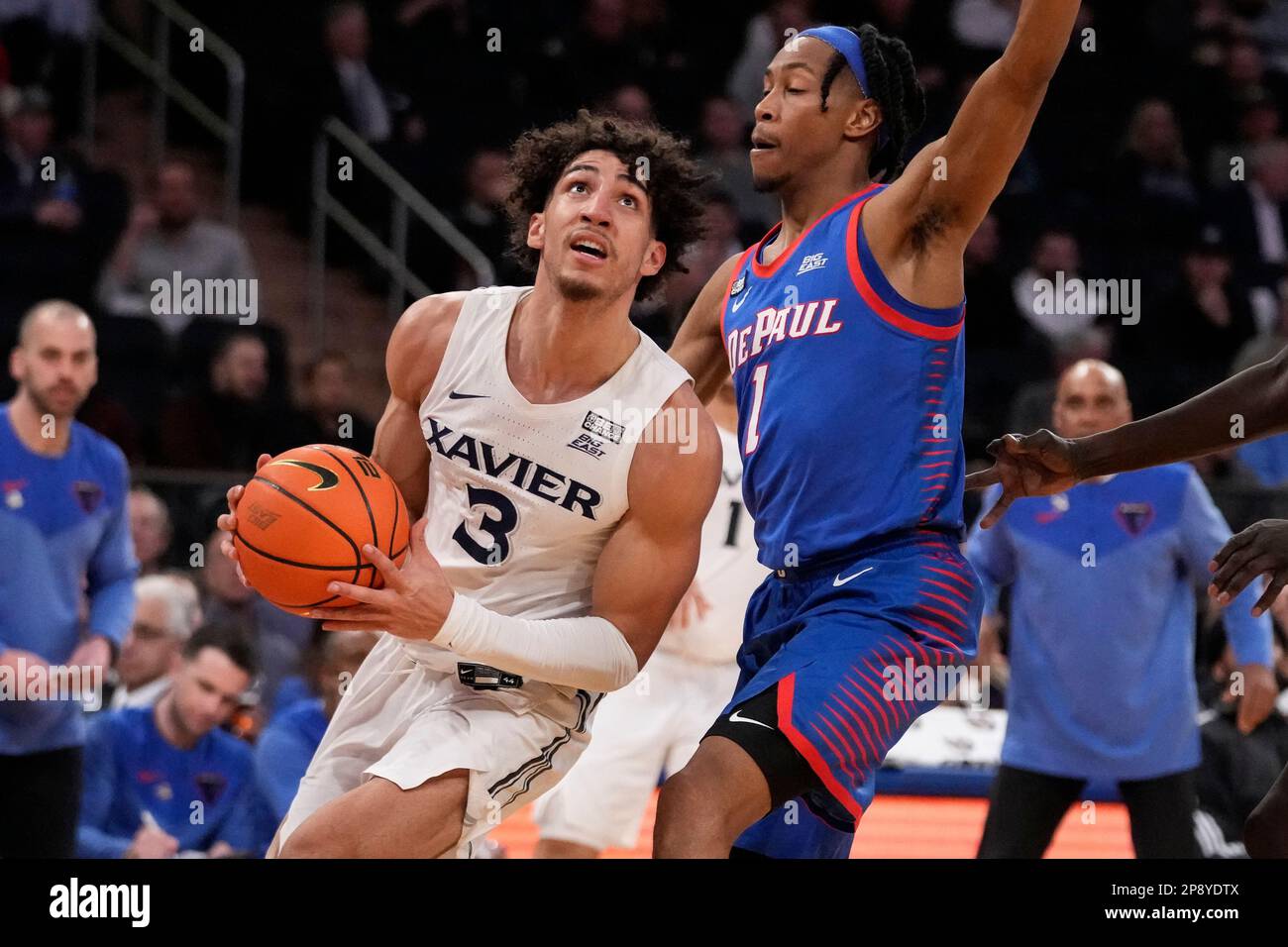 Xavier's Colby Jones (3) drives against DePaul's Javan Johnson (1) in ...