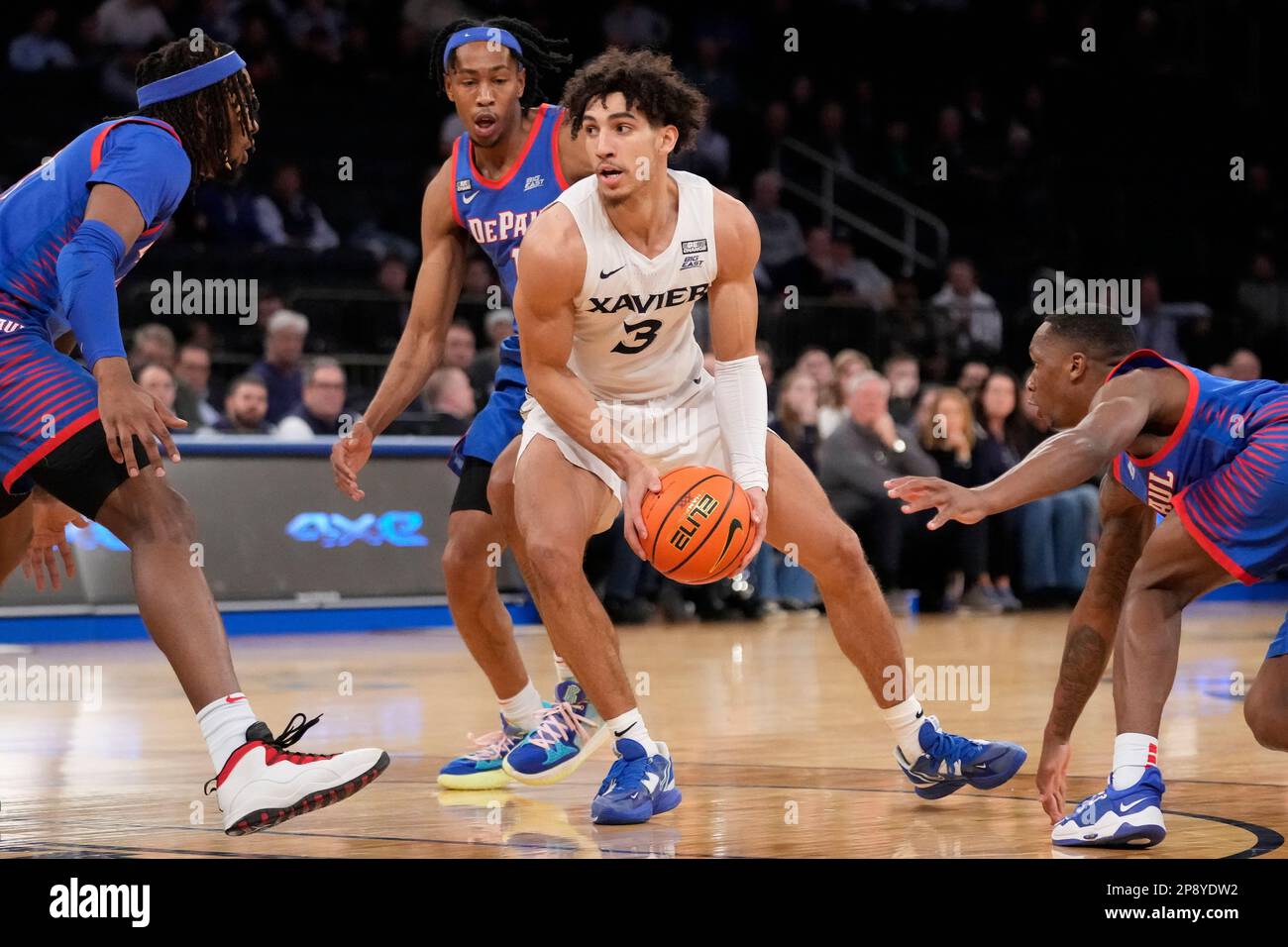 Xavier's Colby Jones (3) looks to pass as he drives around DePaul's ...