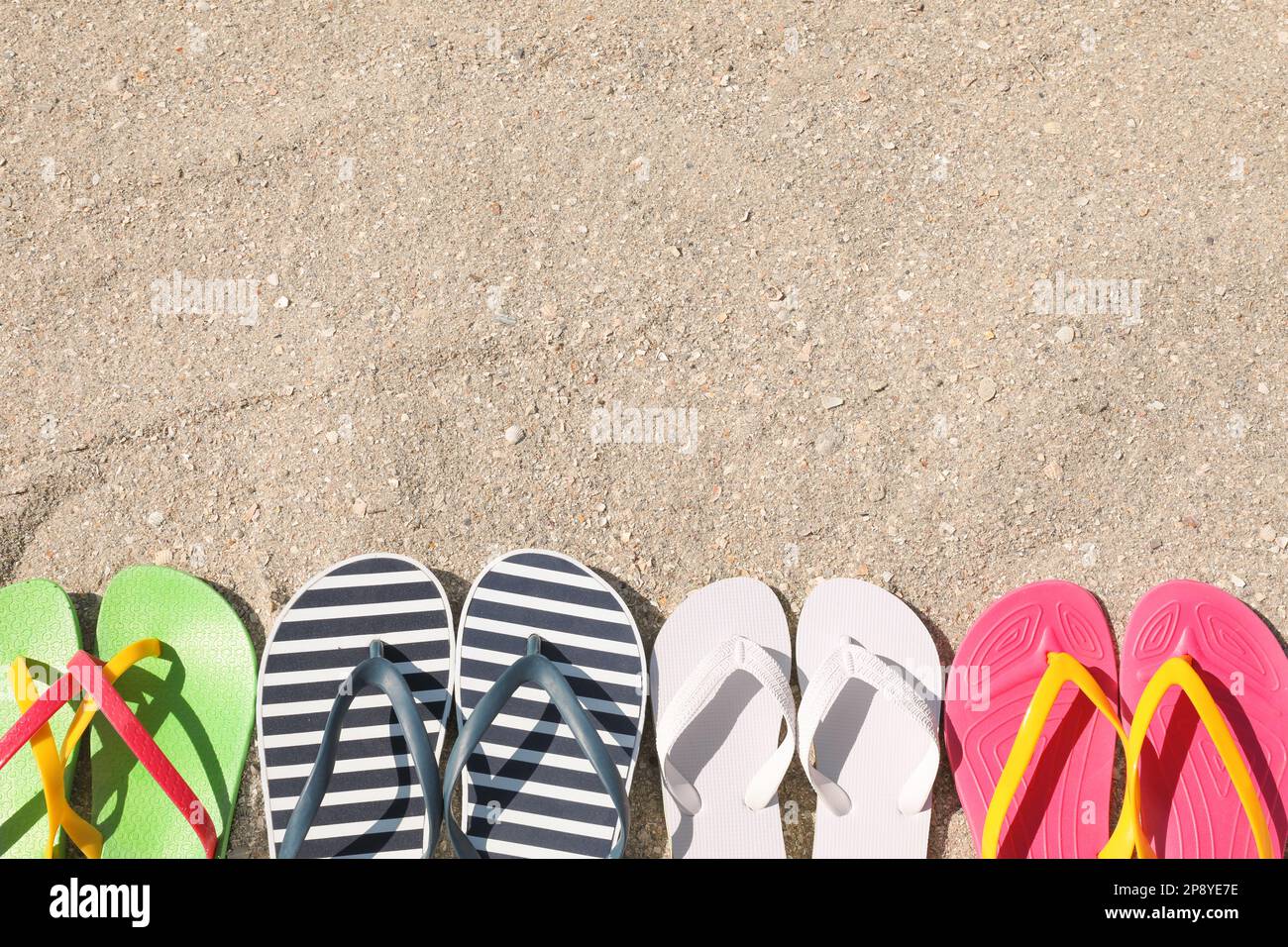 Many different flip flops on sand, flat lay. Space for text Stock Photo ...