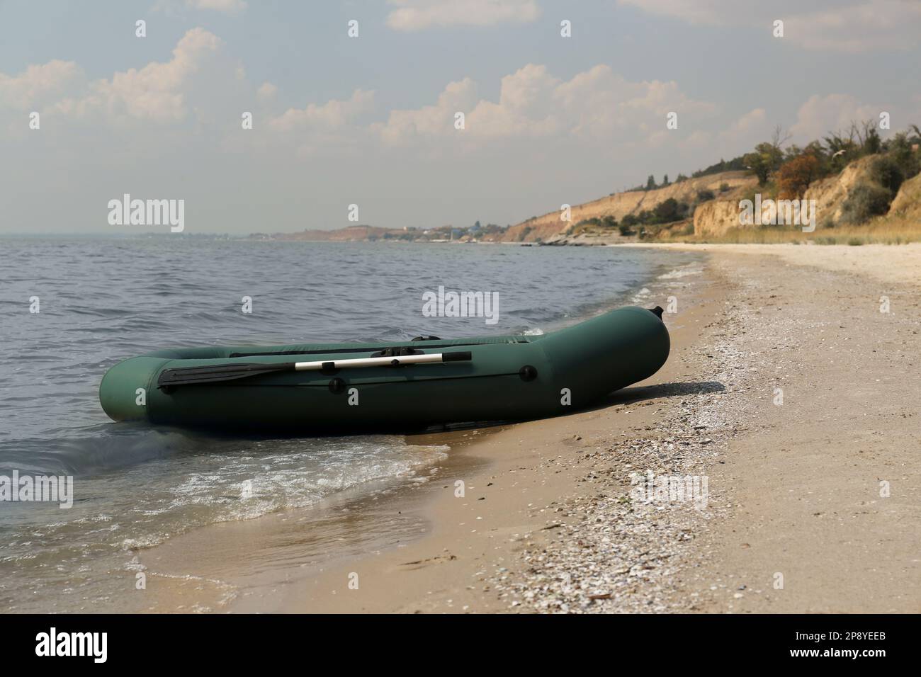 Inflatable rubber fishing boat on sandy beach near sea Stock Photo - Alamy