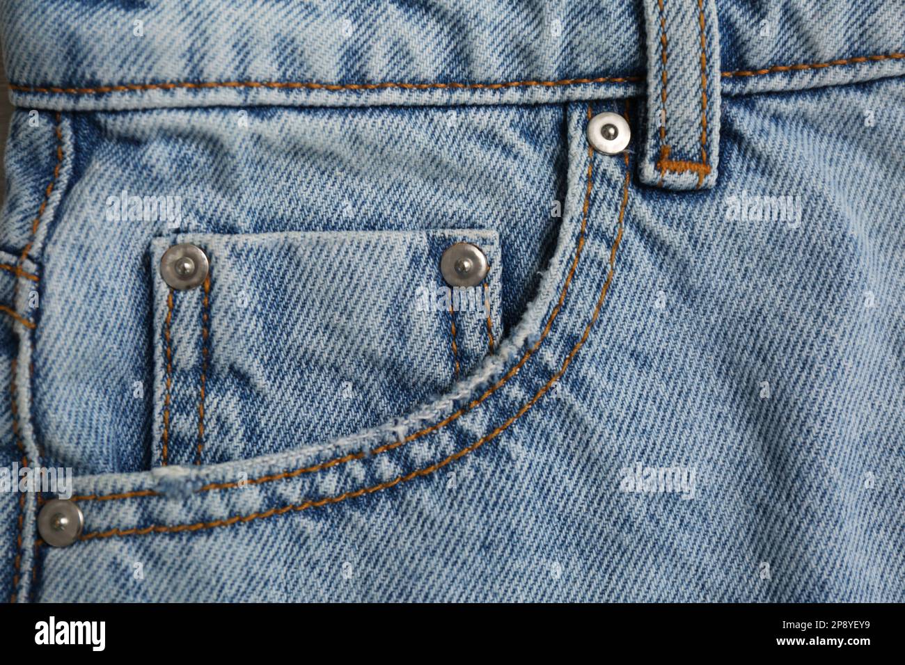 Light blue jeans with inset pocket as background, closeup Stock Photo ...