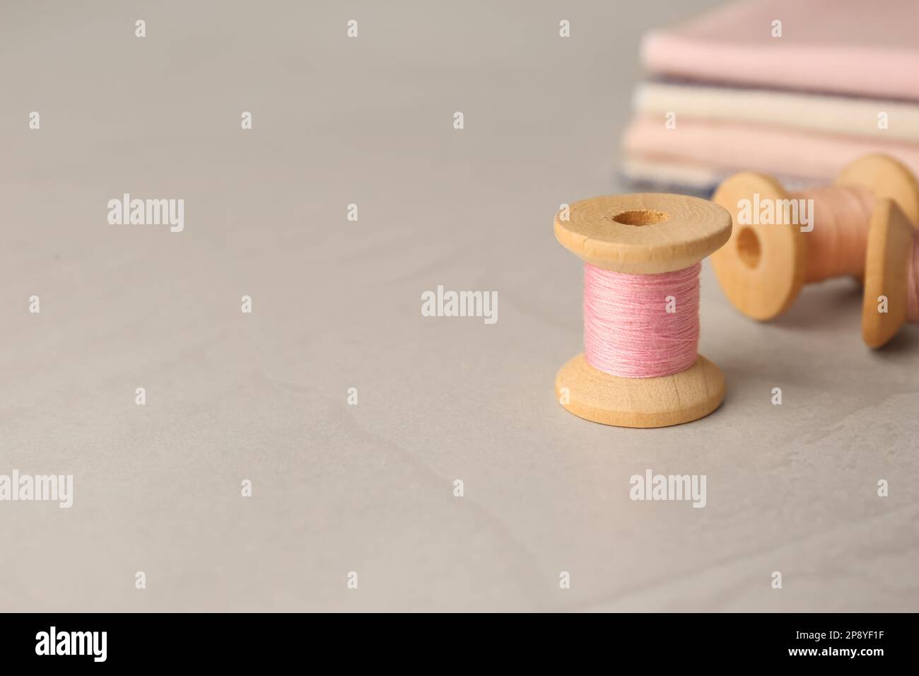 Set of color sewing threads on light grey table, space for text Stock ...