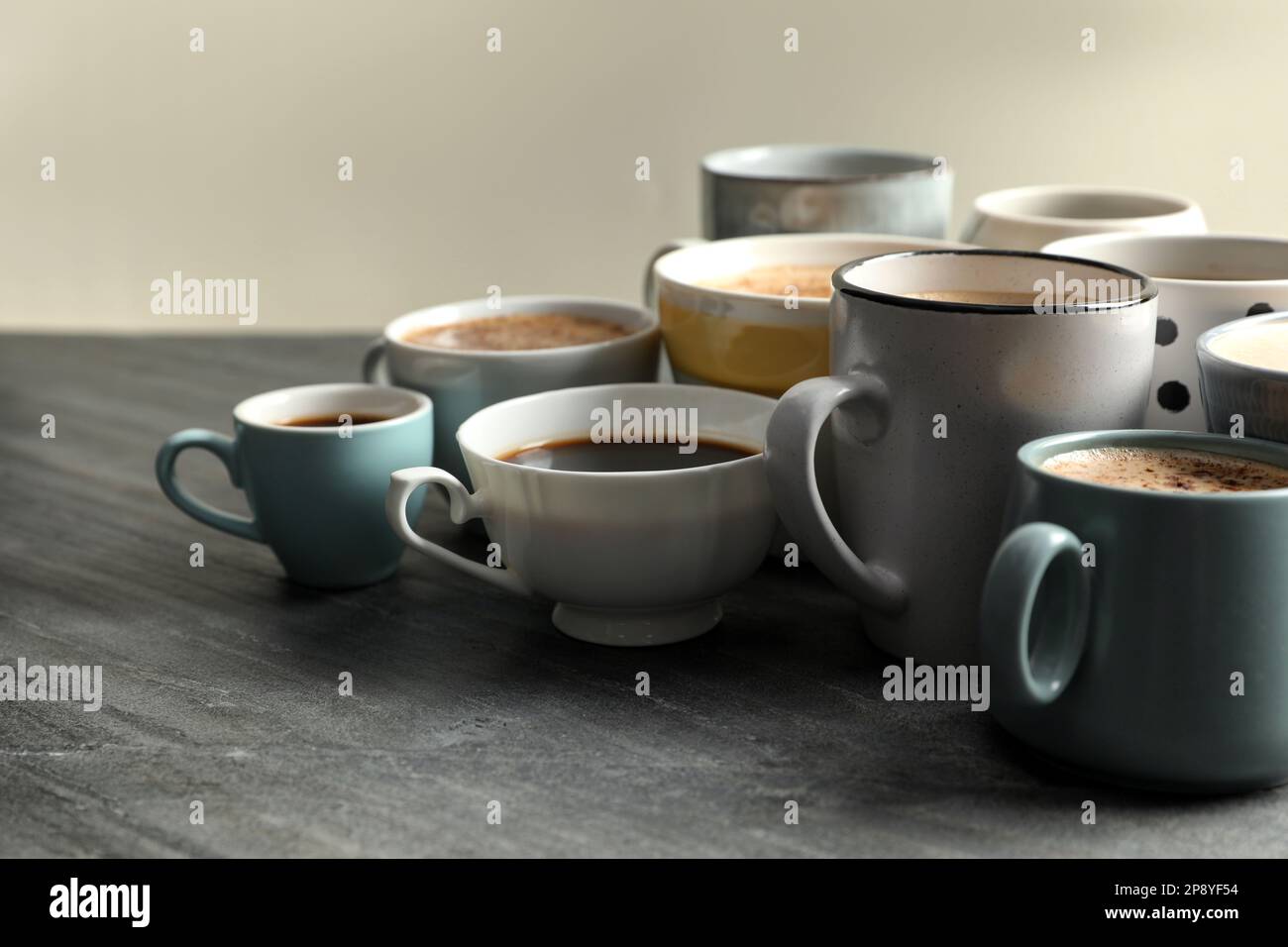 Many cups of different coffees on slate table Stock Photo - Alamy