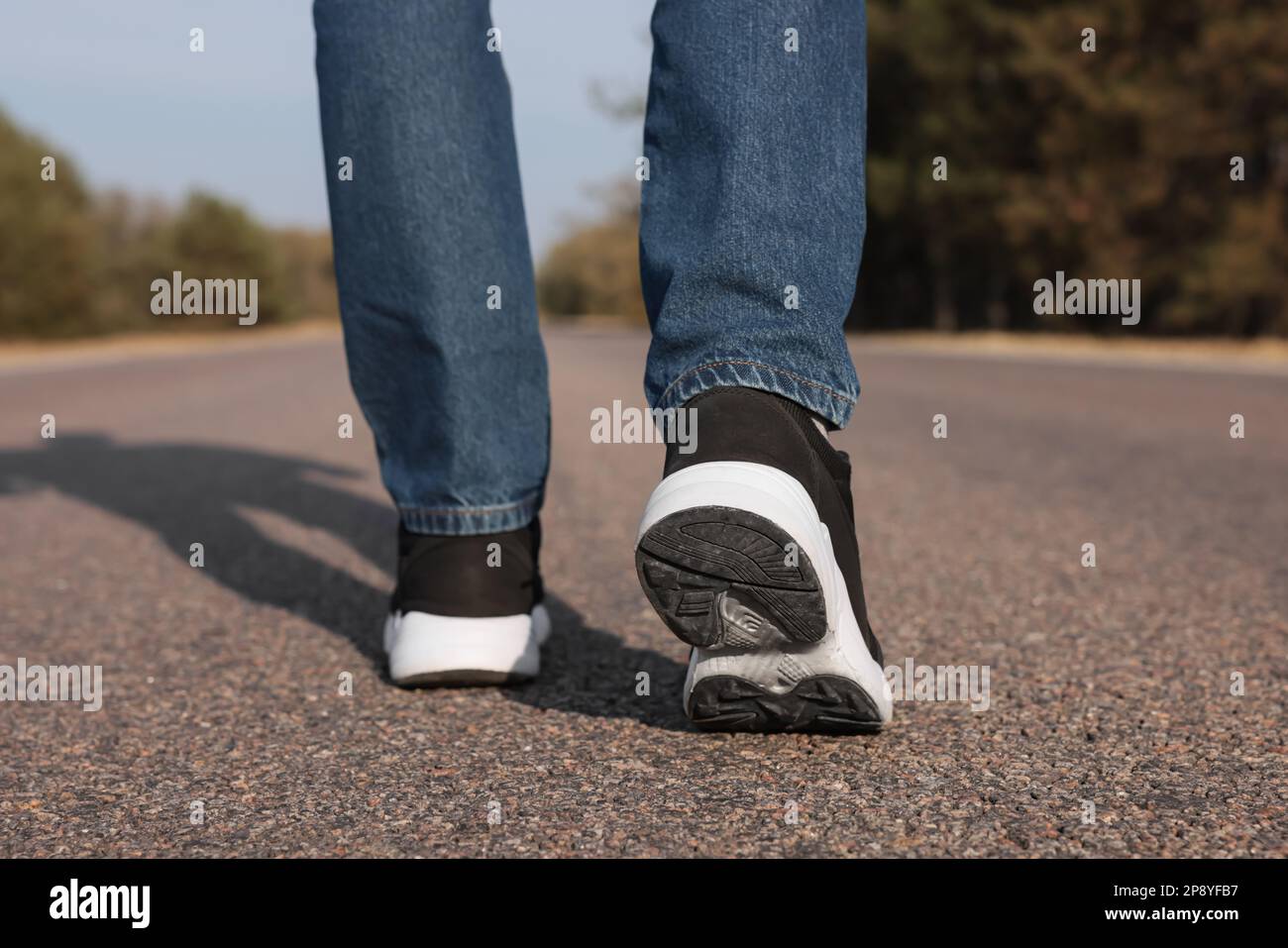 Male legs walking along road hi-res stock photography and images - Alamy