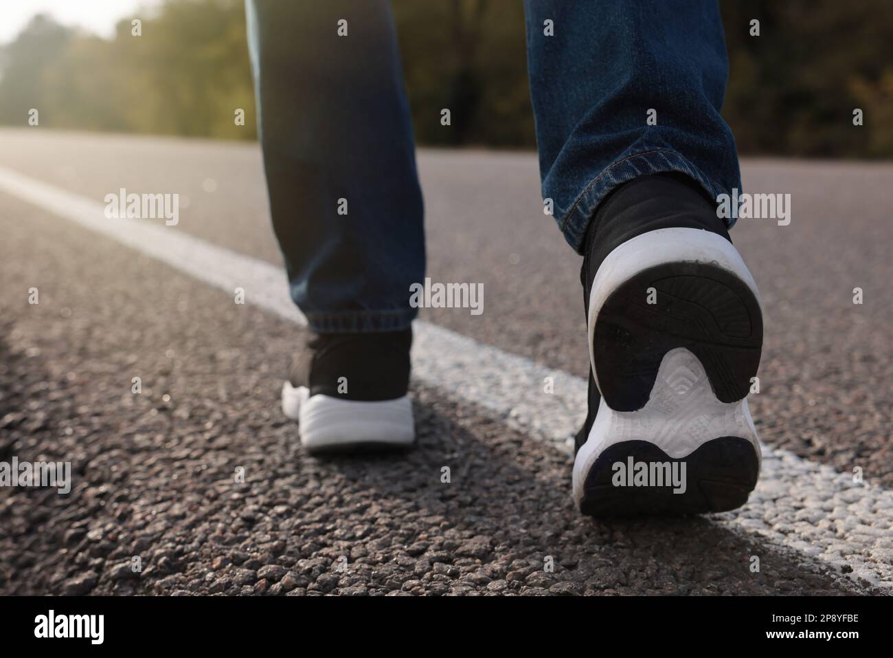 Man going along road, closeup of legs Stock Photo - Alamy