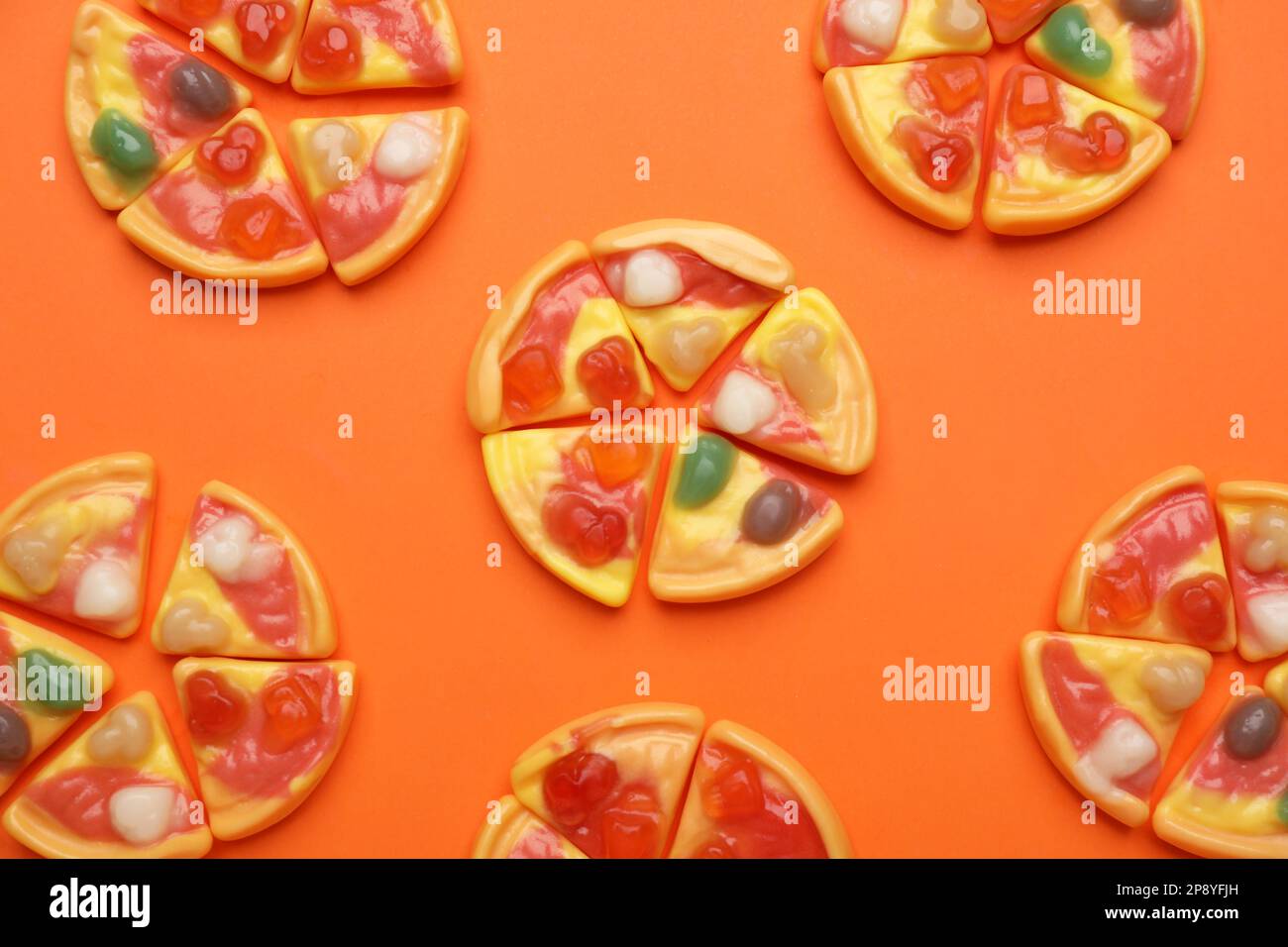 Delicious gummy pizza candies on orange background, flat lay Stock ...