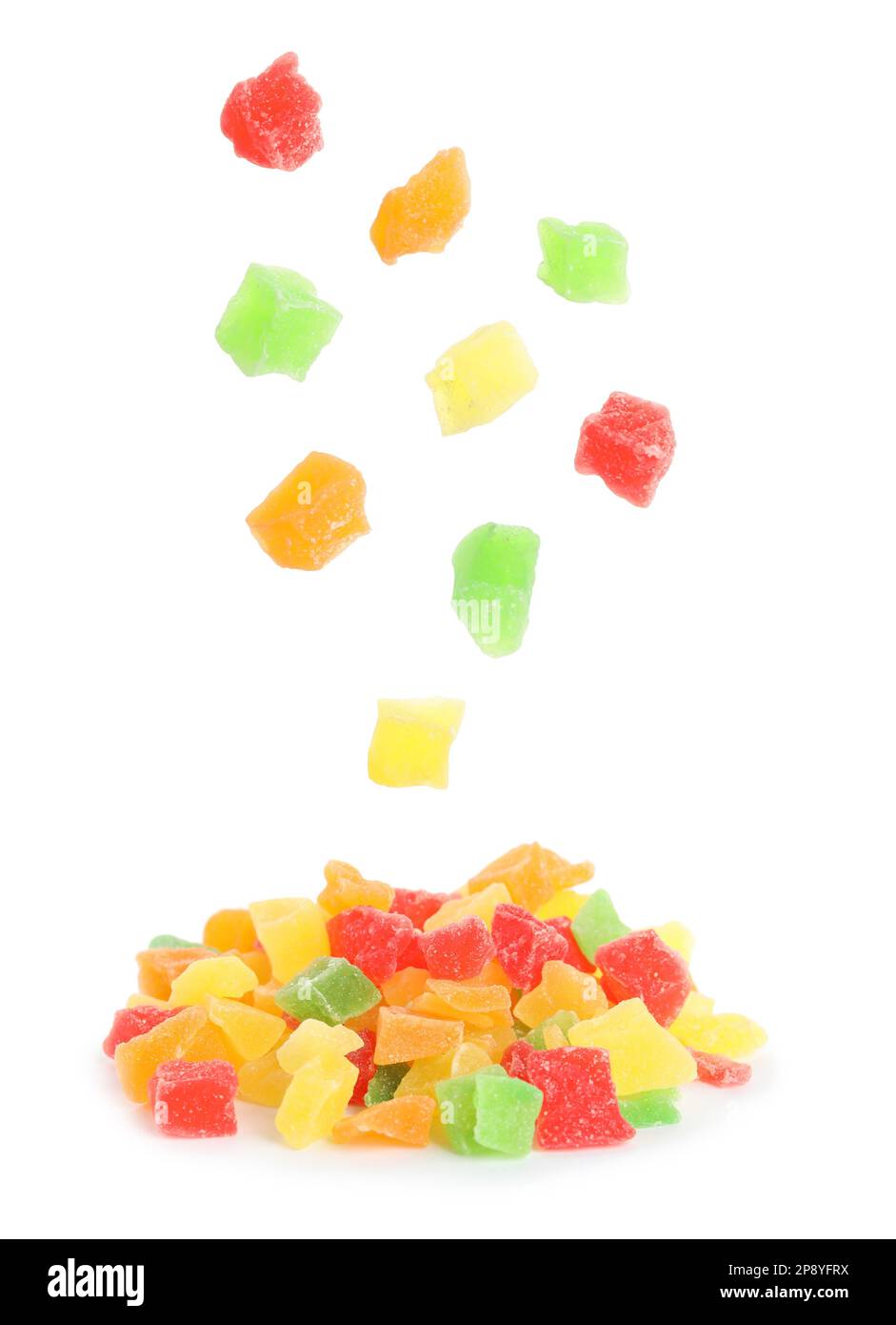 Tasty pieces of candied fruits falling into pile on white background ...