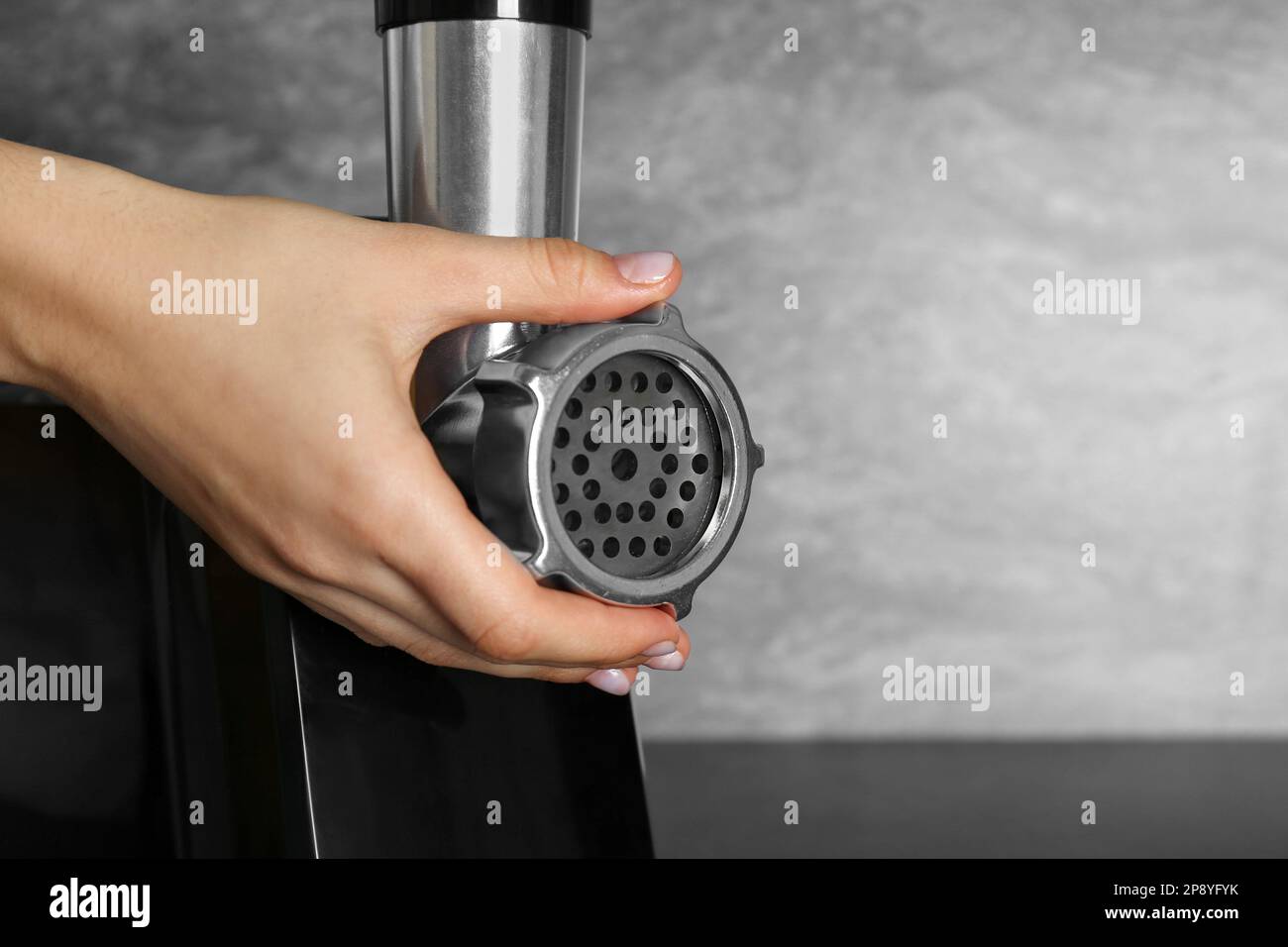 Woman assembling electric meat grinder, closeup. Space for text Stock ...