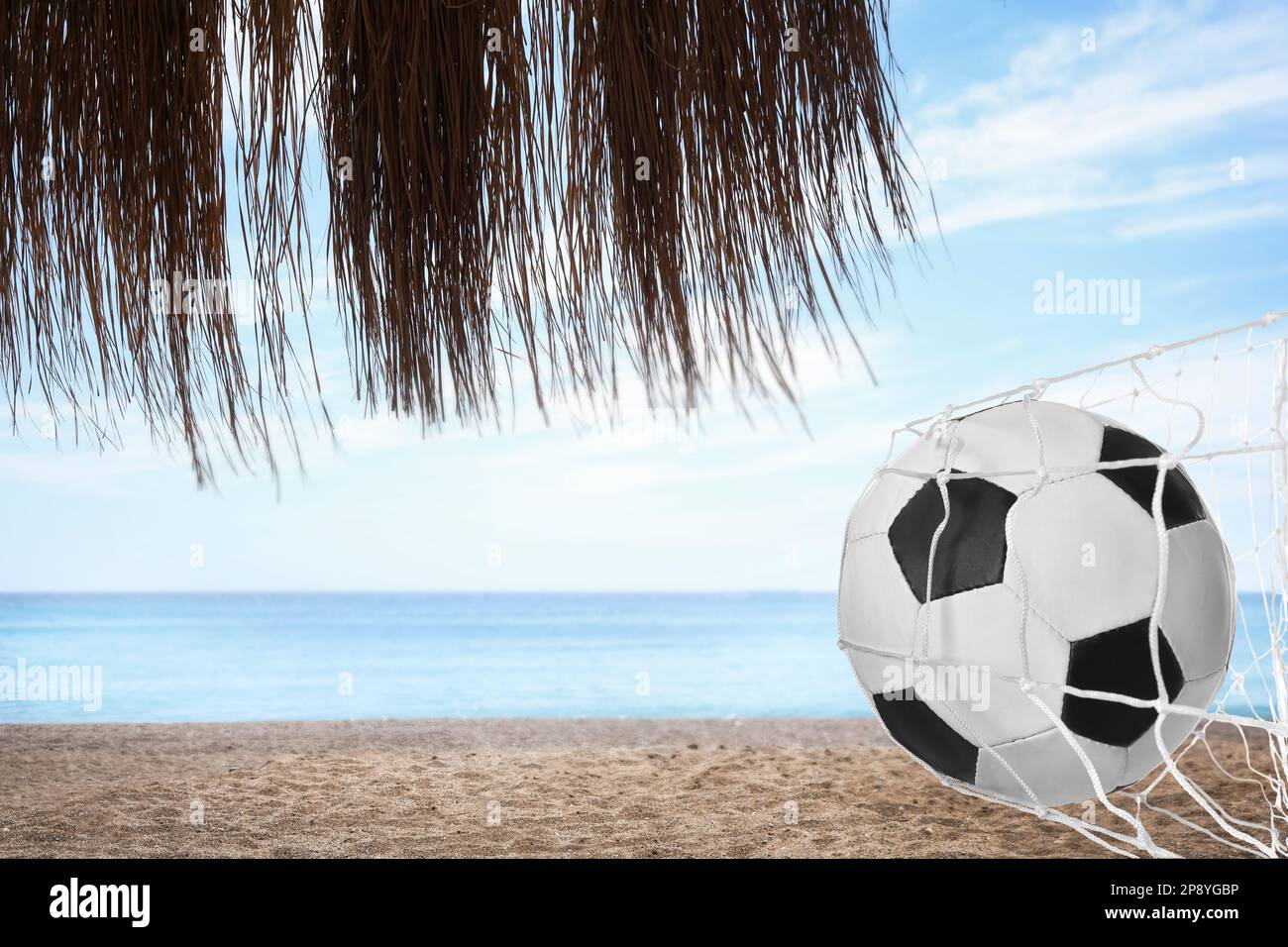 Soccer ball in net on sandy coast near sea. Beach football Stock Photo ...