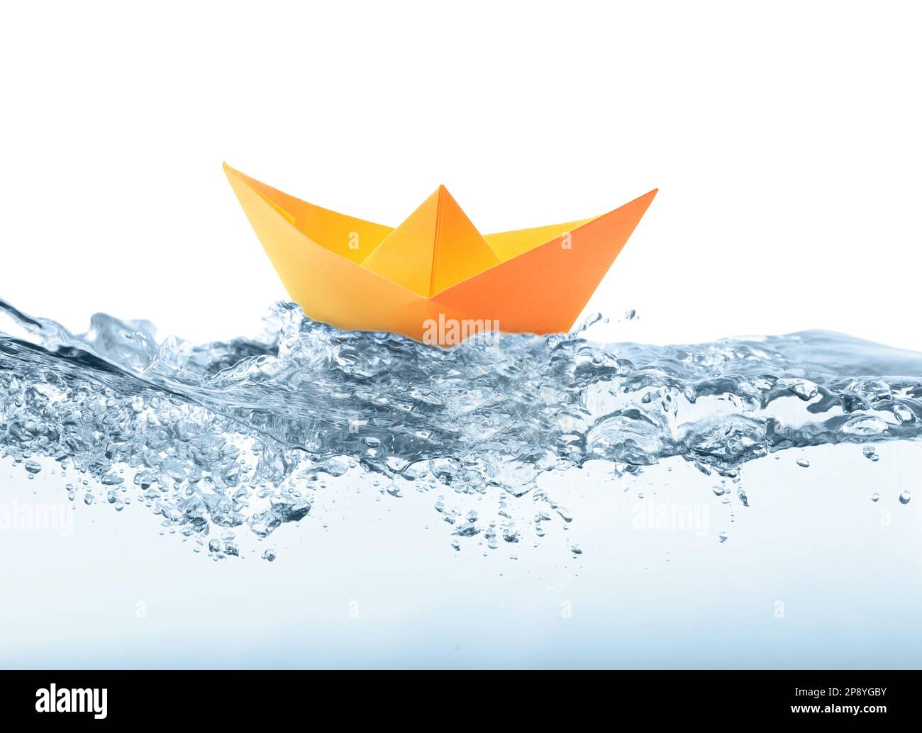 Handmade orange paper boat floating on clear water against white ...