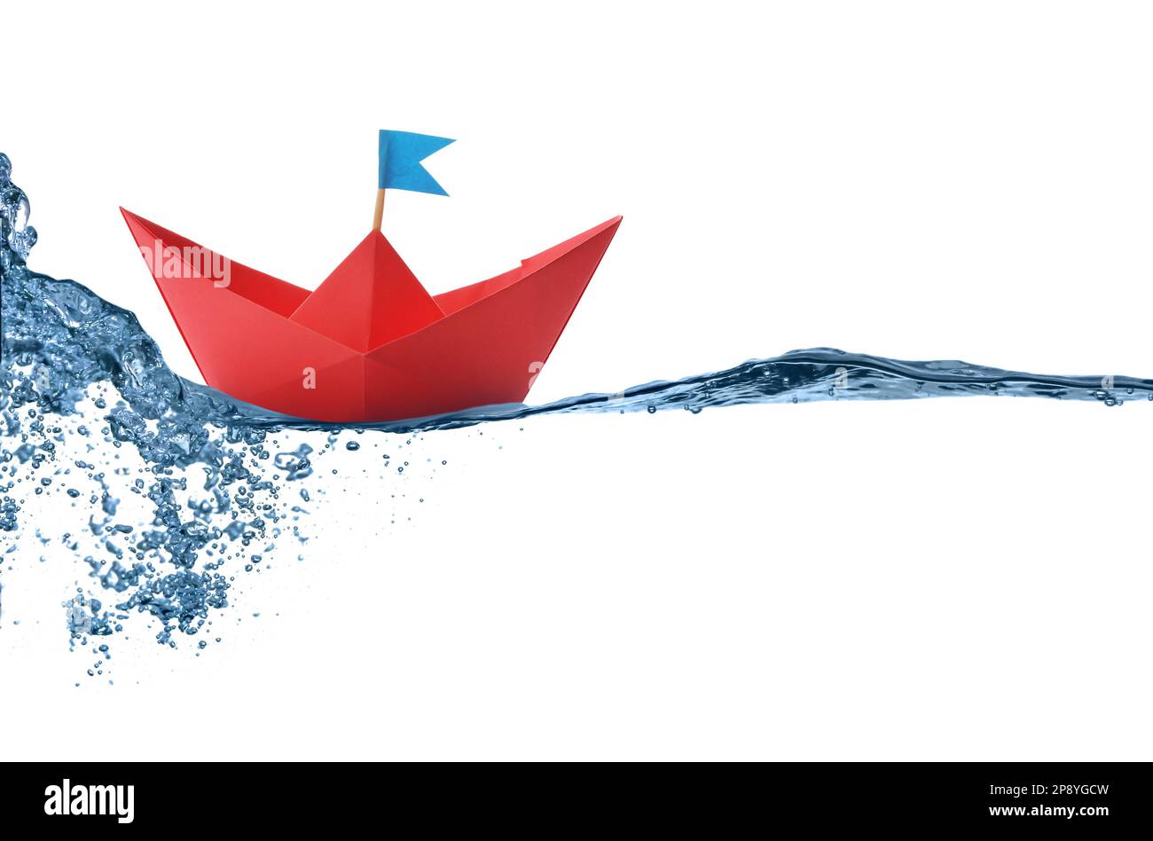 Handmade red paper boat floating on clear water against white ...