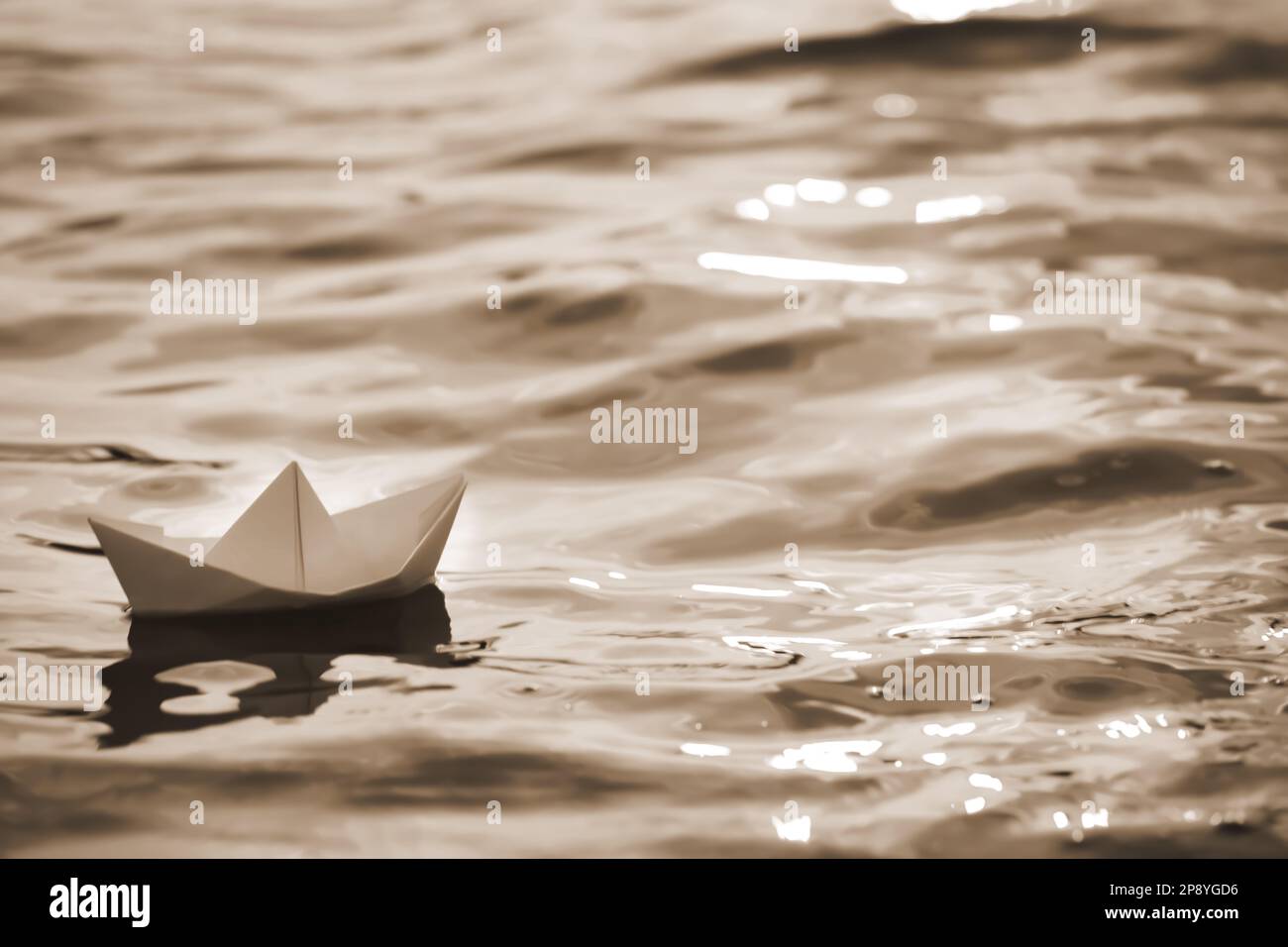 Paper boat floating on river. Retro photo effect Stock Photo - Alamy
