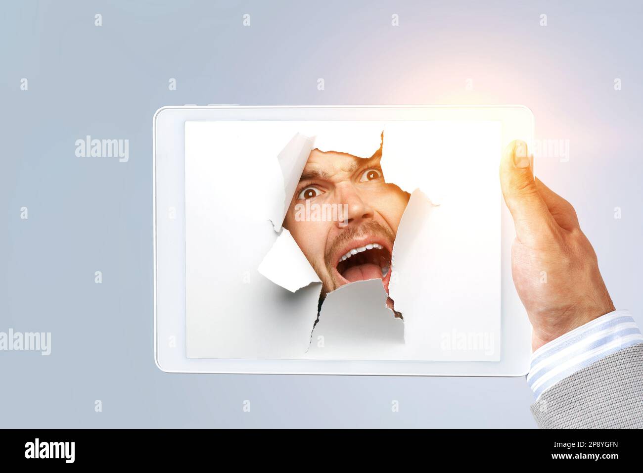 Male face through the hole in paper Stock Photo - Alamy