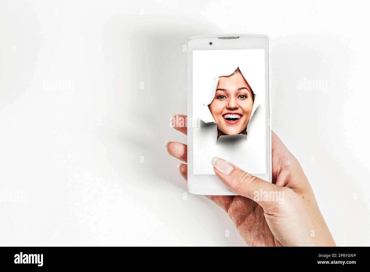 Female face through the hole in paper Stock Photo - Alamy
