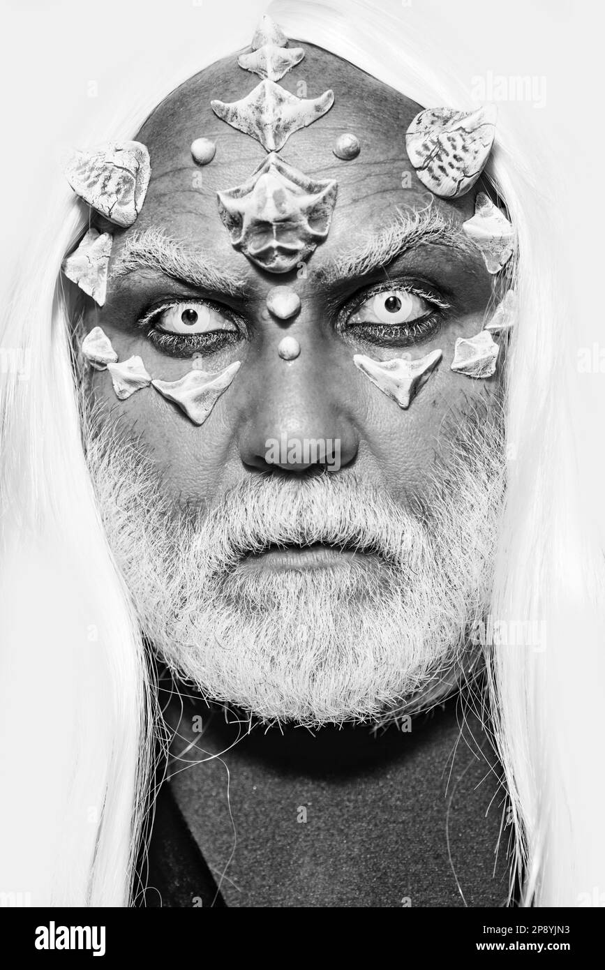 Ancient alchemy. Monster with white blue eyes. Wizard demon man with ...