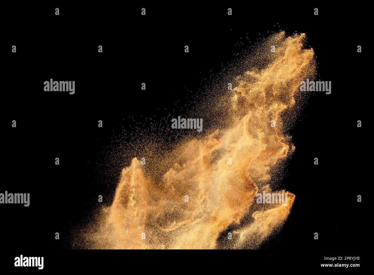 Brown sand explosion isolated on black background. Freeze motion of ...