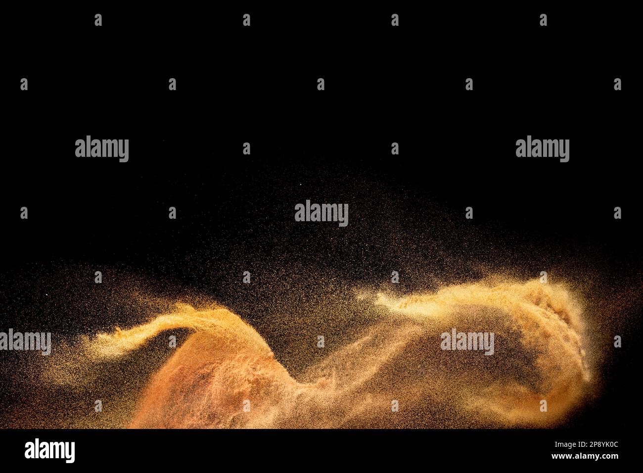 Brown sand explosion isolated on black background. Freeze motion of ...