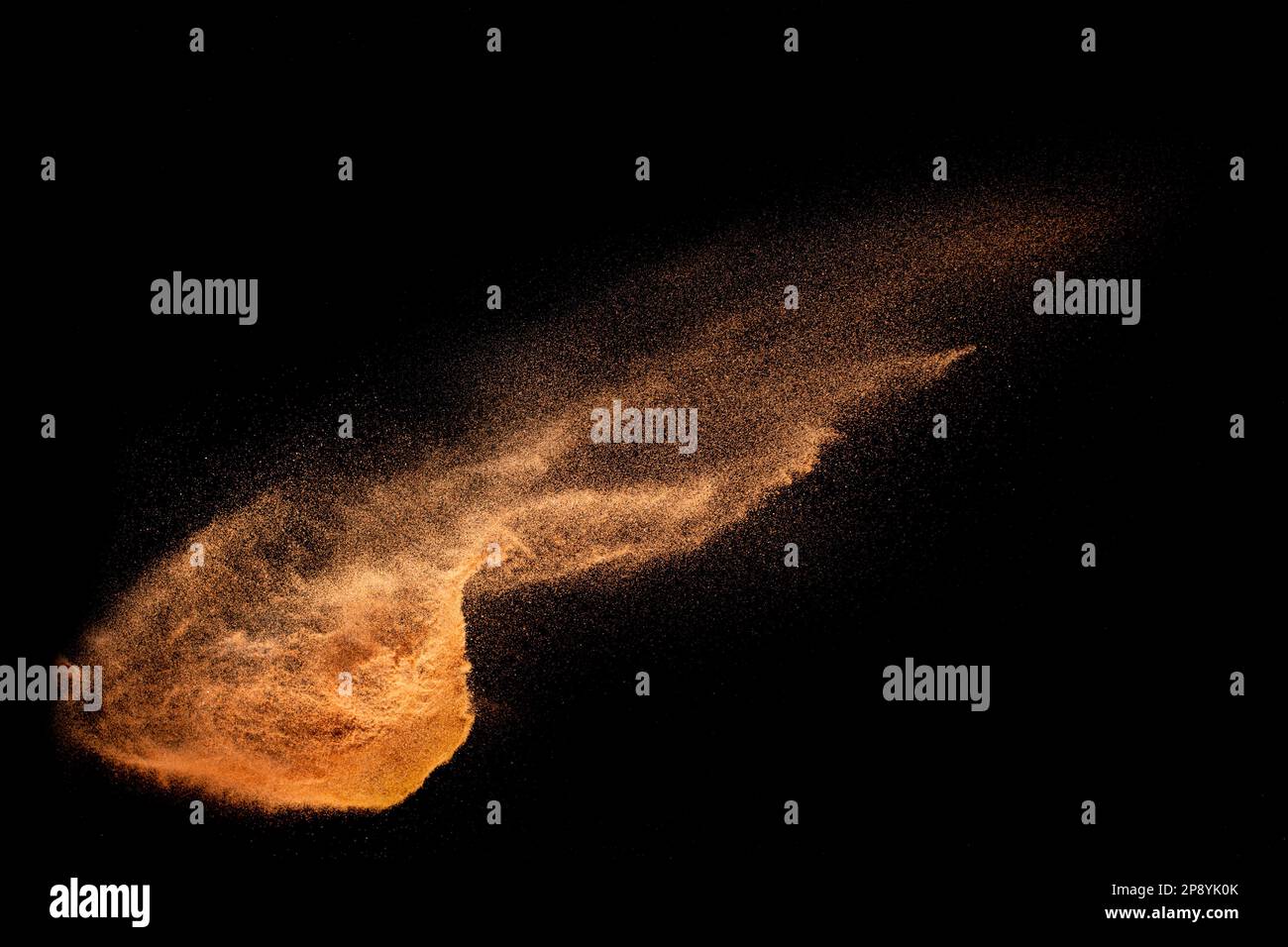 Brown sand explosion isolated on black background. Freeze motion of ...