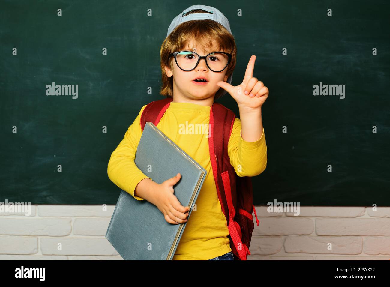 Cute little preschool kid boy in a classroom. Private school. Ready for ...