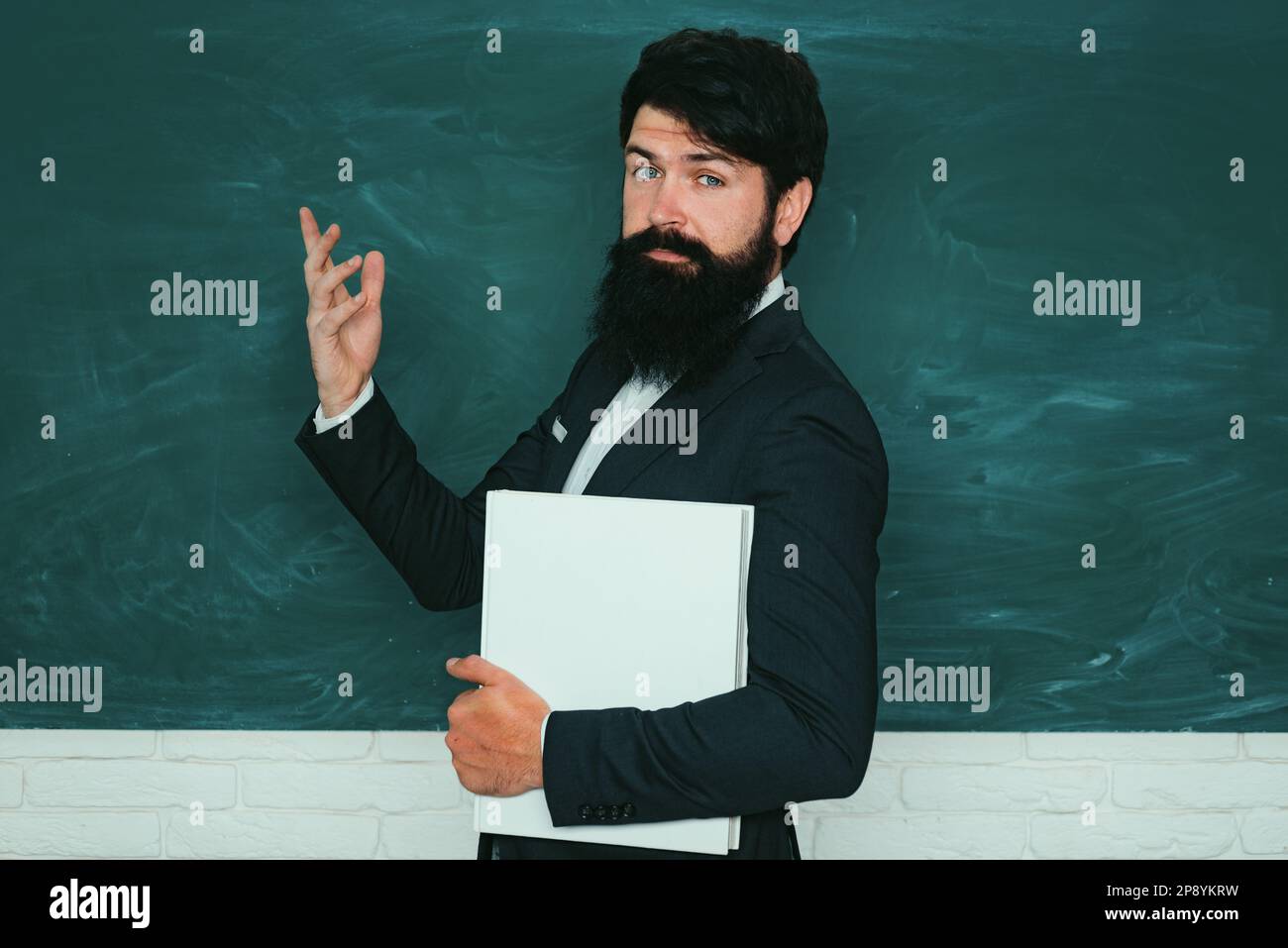 Professor in class on blackboard background. Chalkboard copy space ...